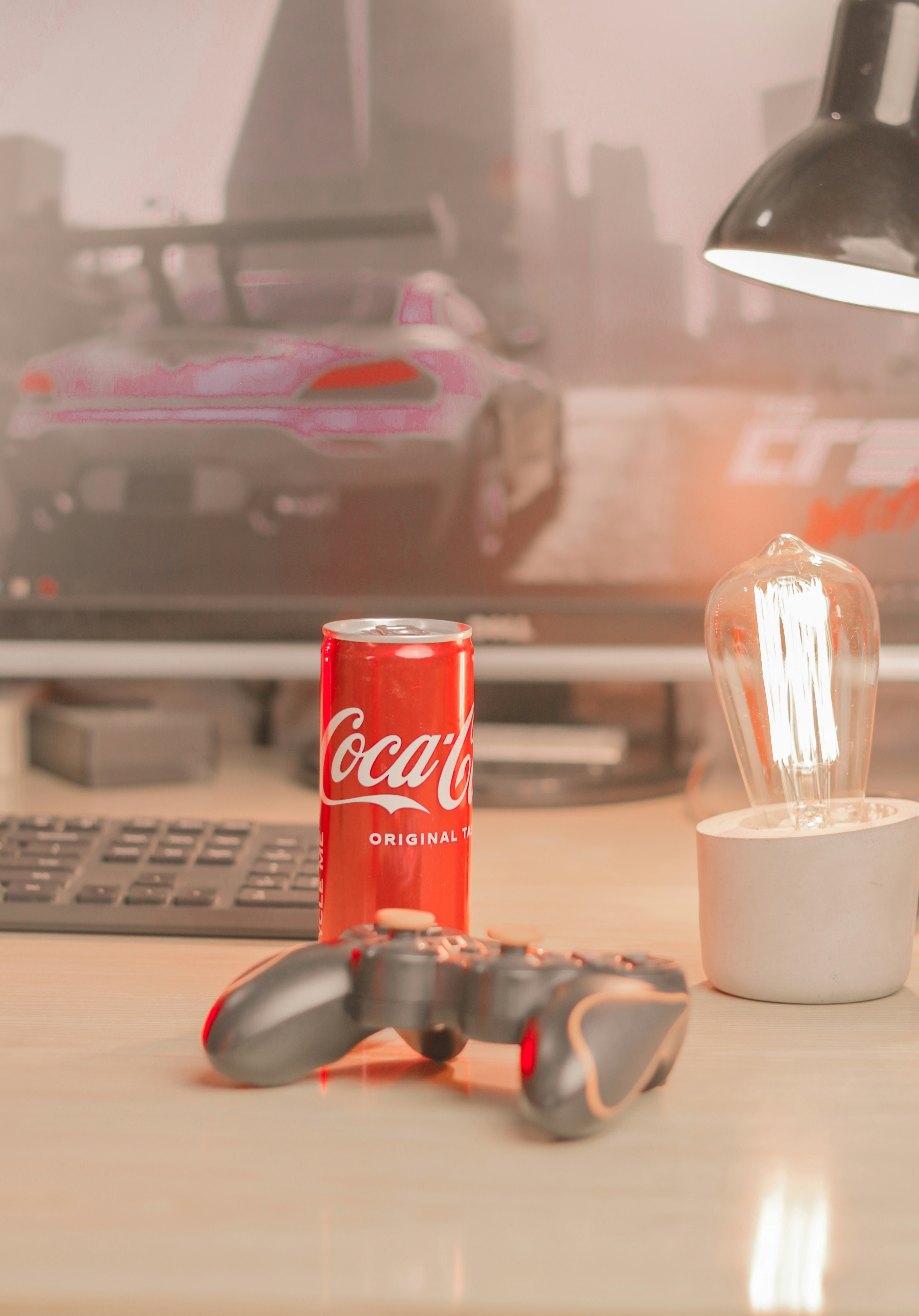 A desk with a can of coca - cola and two controllers photo – Free Soda ...