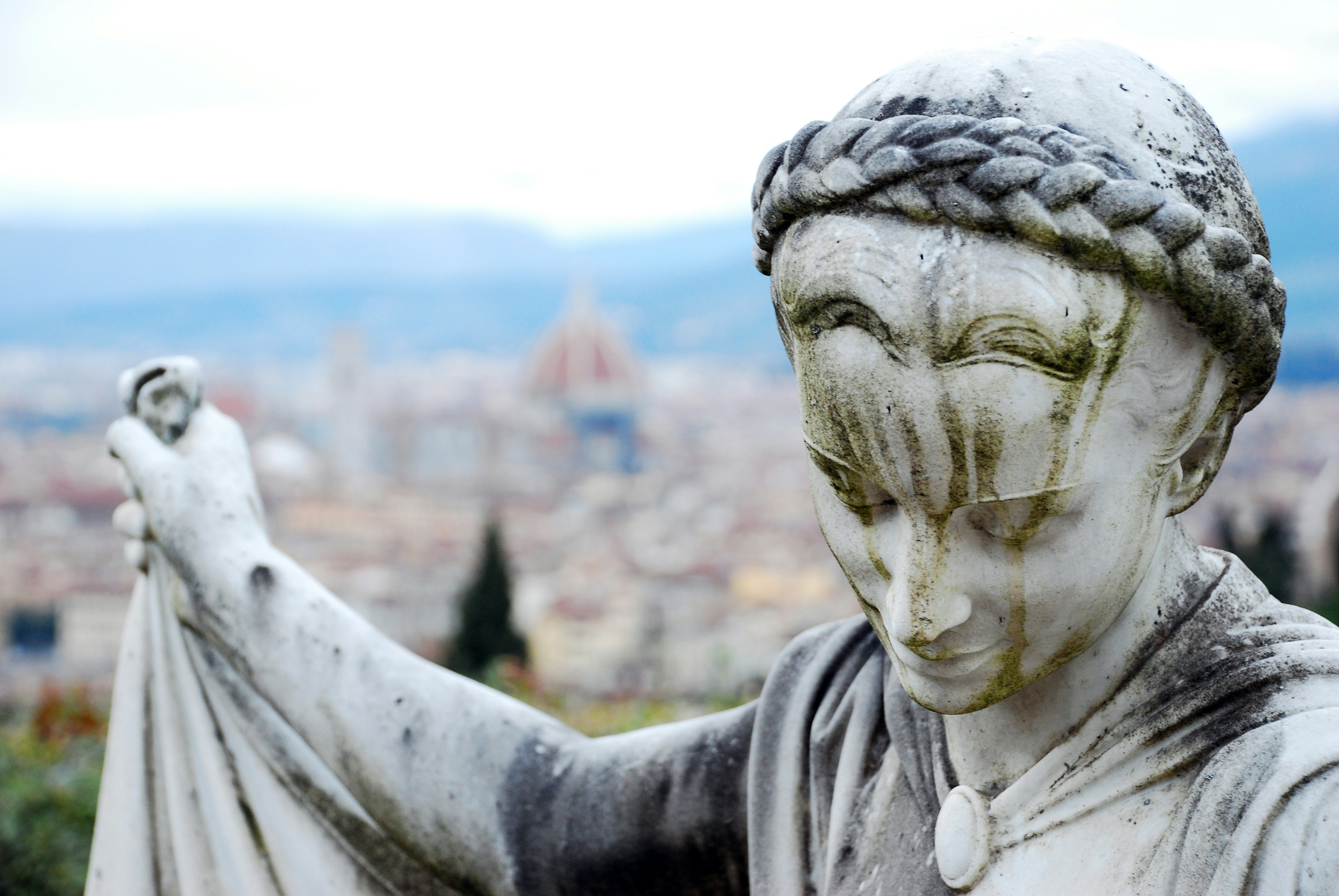 a statue of a person holding a piece of cloth