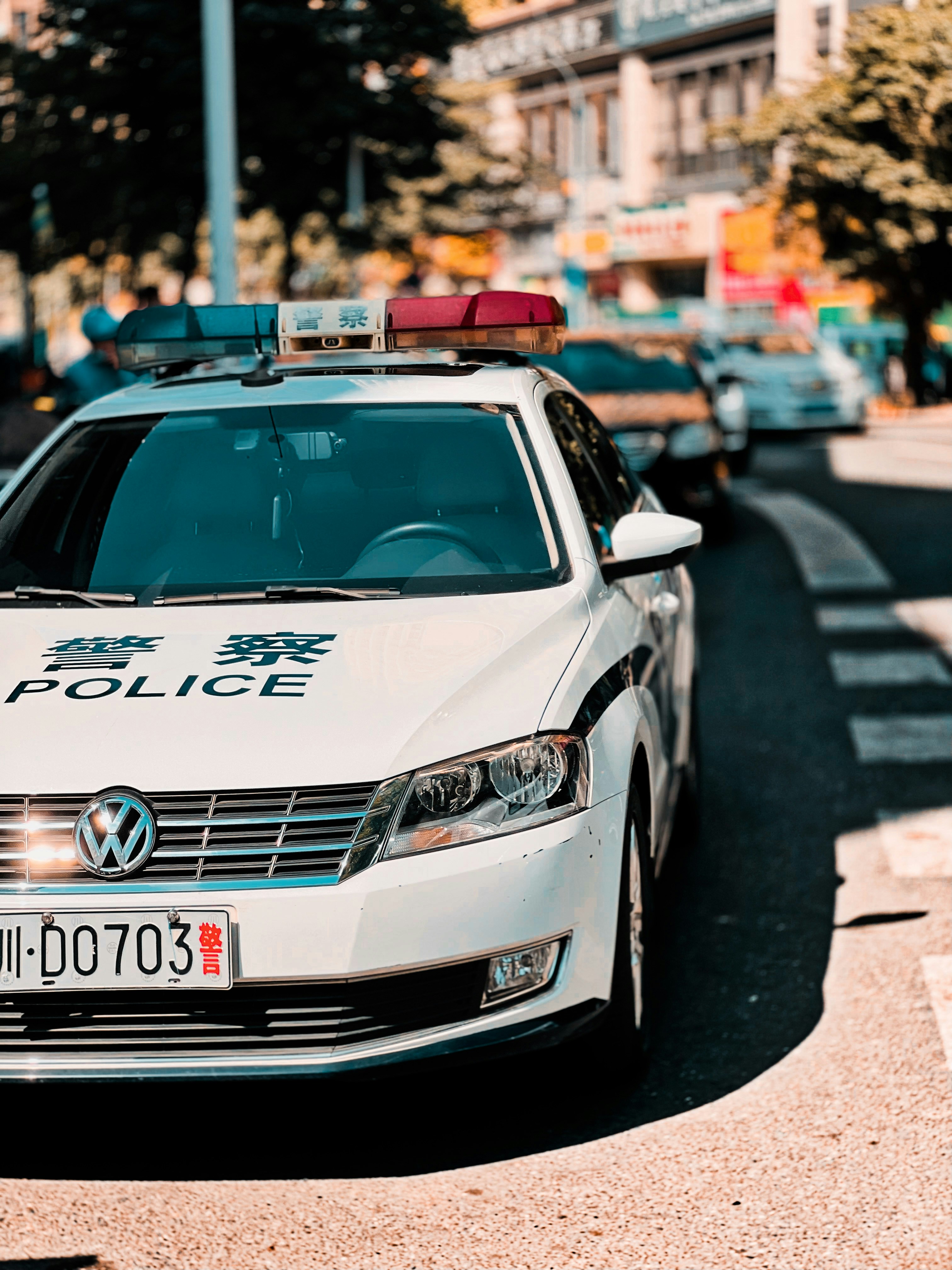 Police Sedan at Dawn: A Street Scene with Siren Light