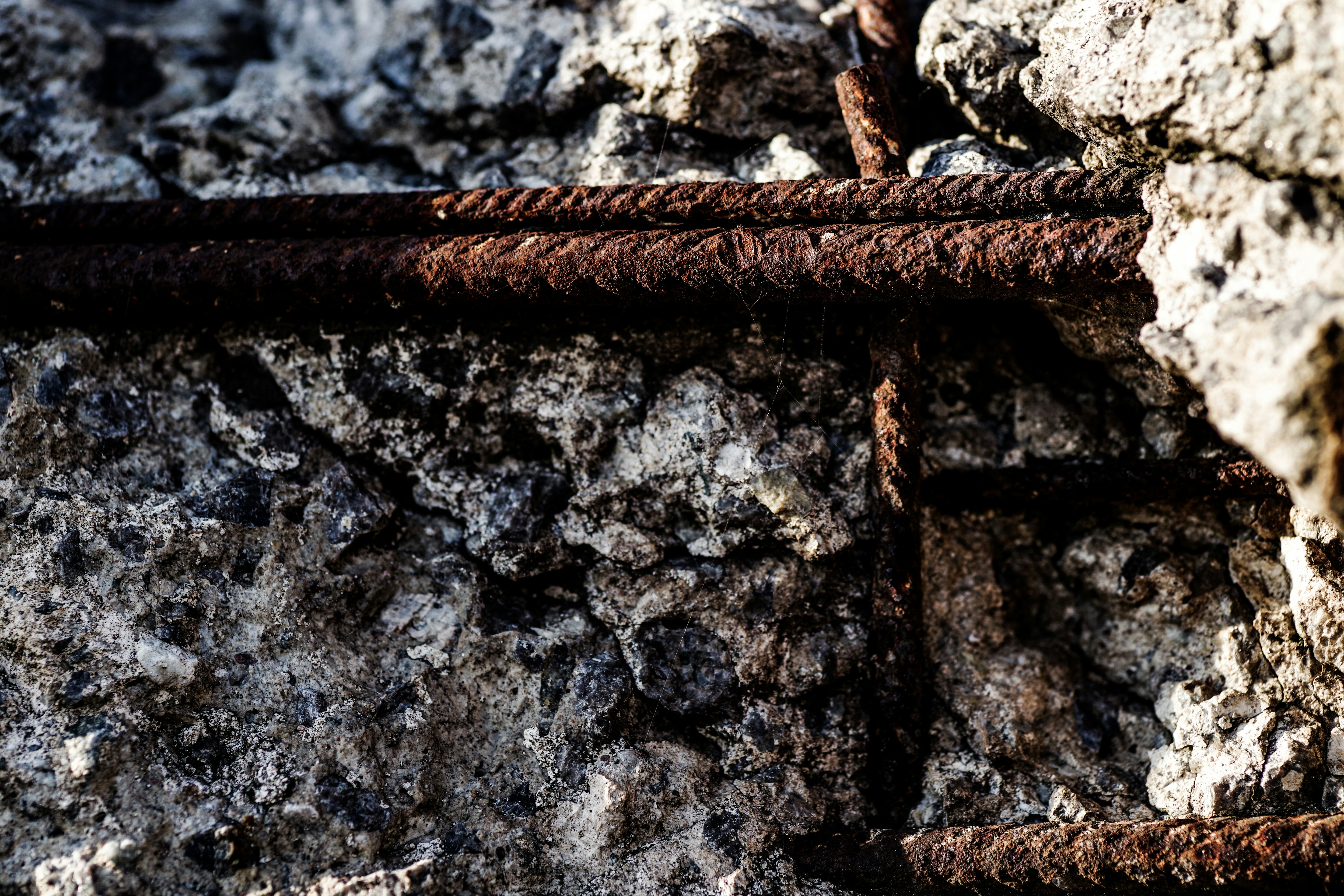 A rusty iron bar on a rock wall photo – Free Metal Image on Unsplash