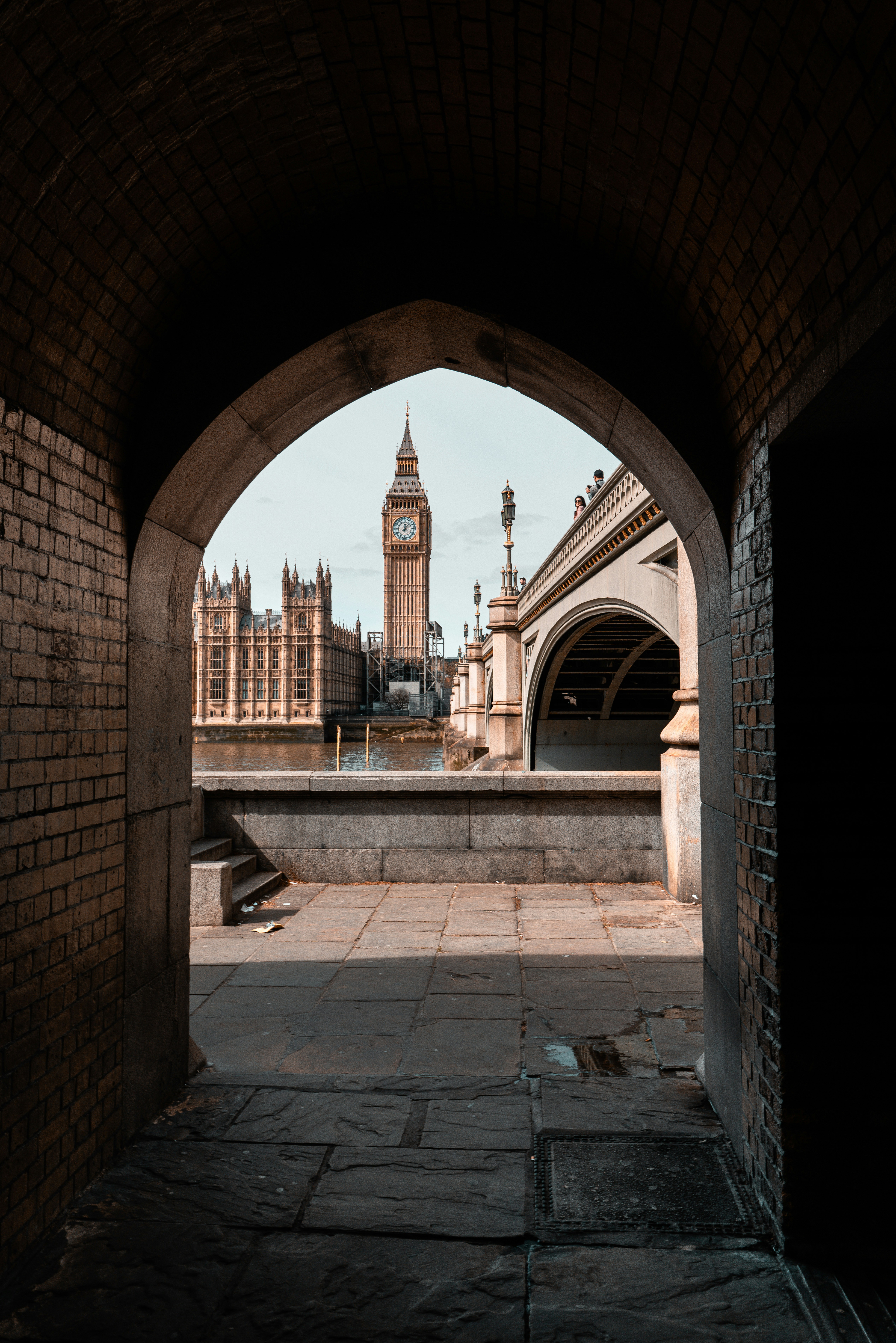 A view of a clock tower through an archway photo – Free Architecture ...