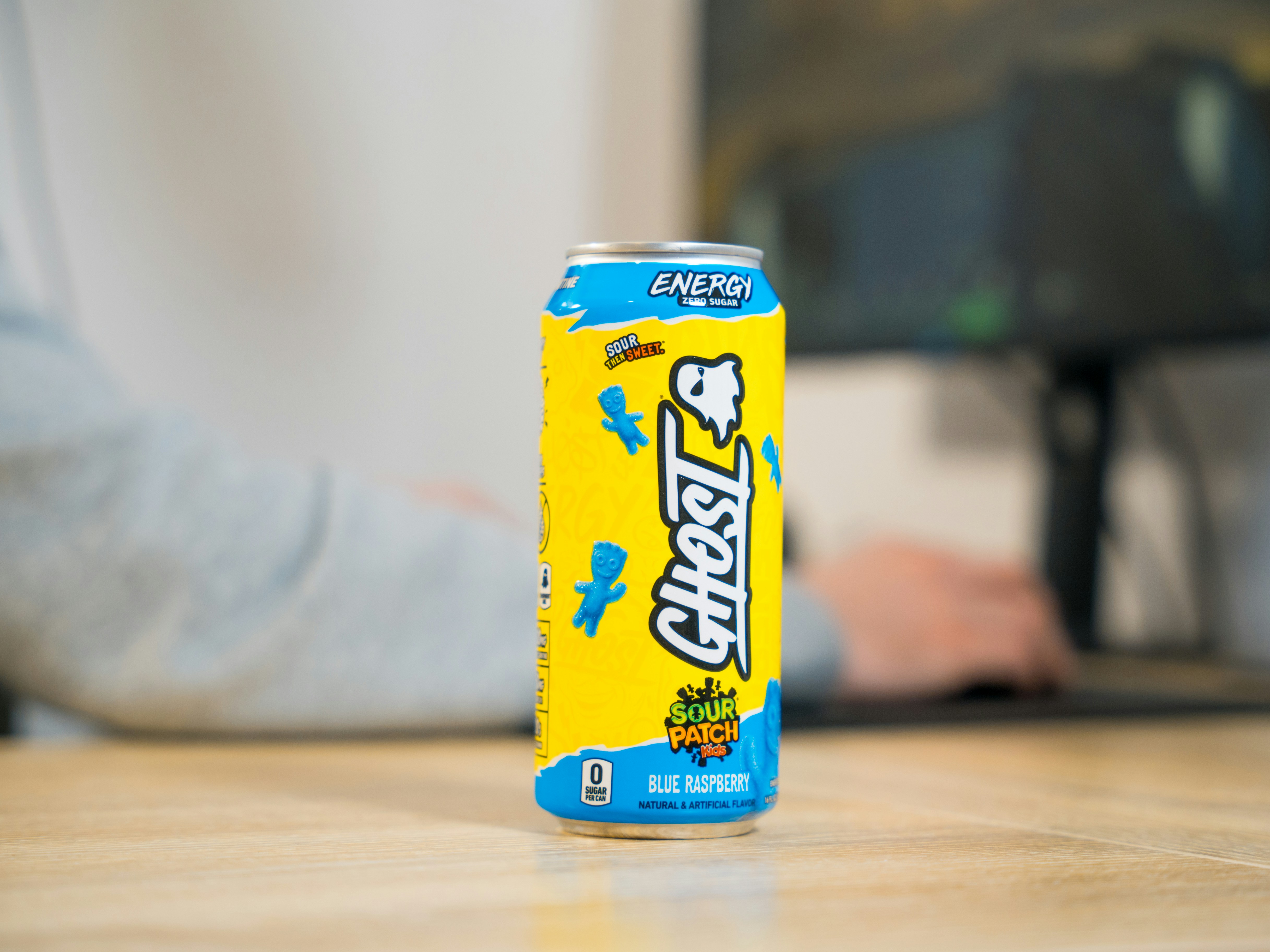 a can of soda sitting on top of a wooden table