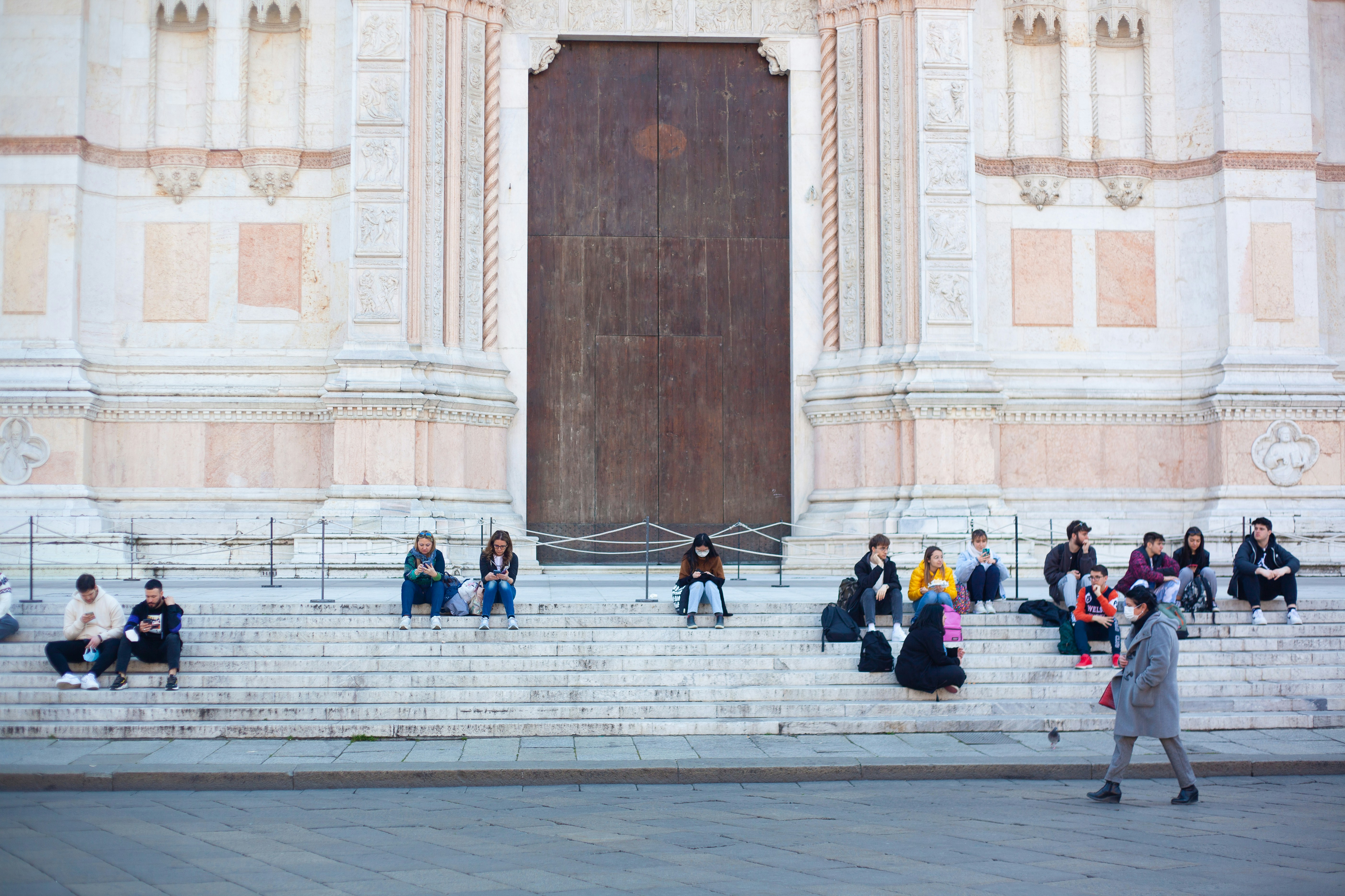Lone Walker on Marble Steps Before a Monumental Gate