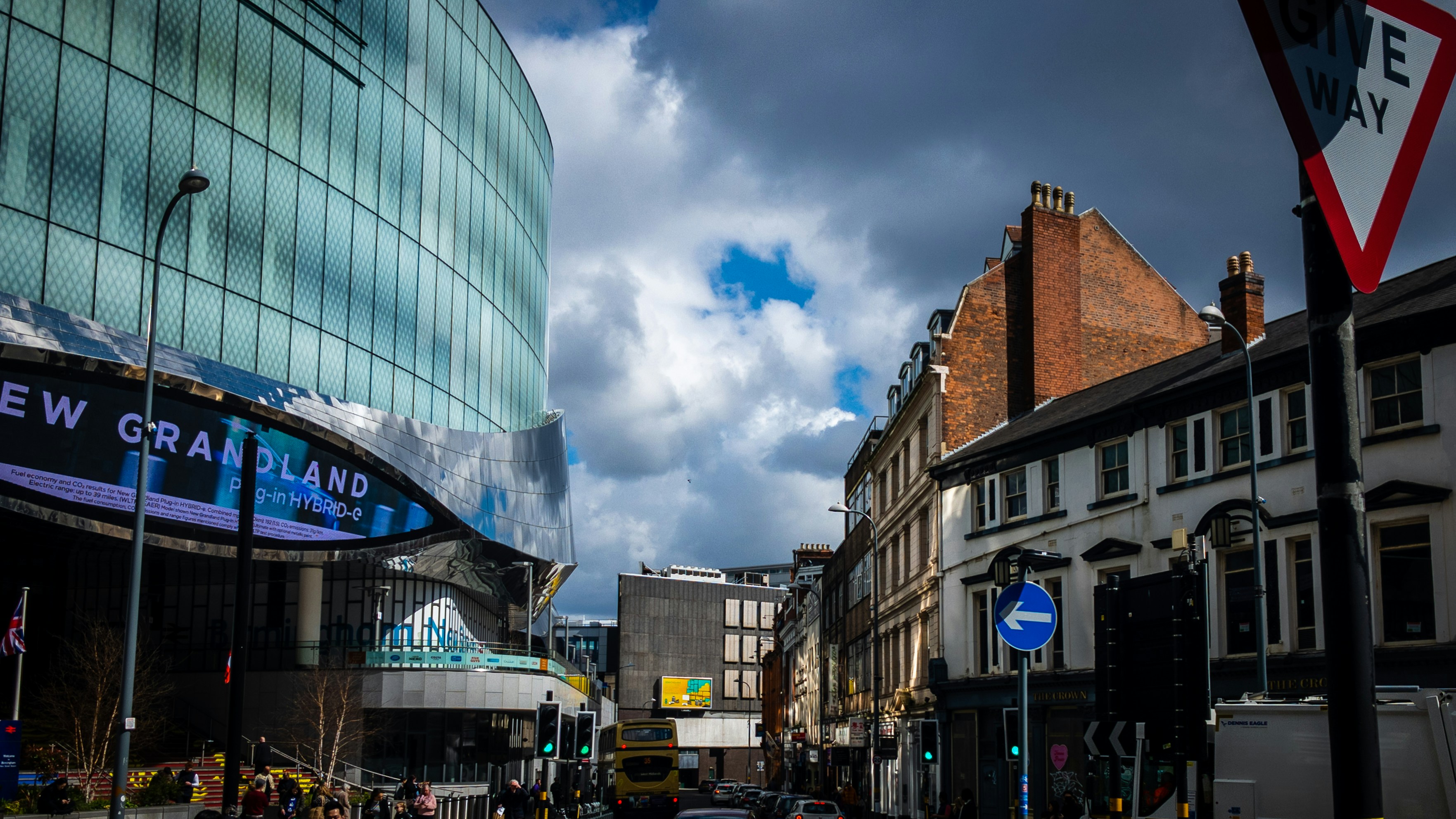 Curved Glass Over Brick Streets: A City Block Framed by Modern and Historic Architecture