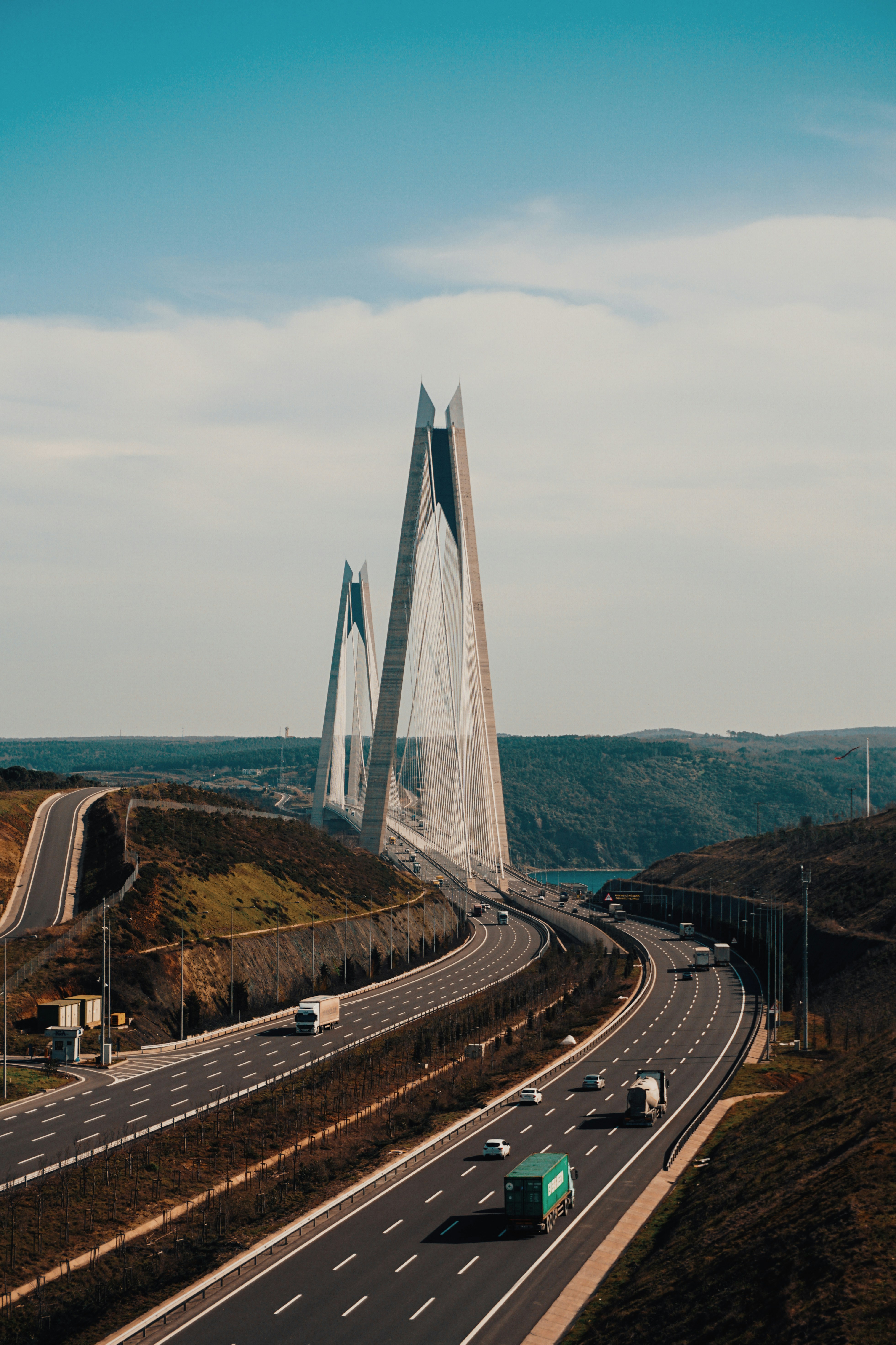 Twin Sail Pylons Framing a Winding Highway