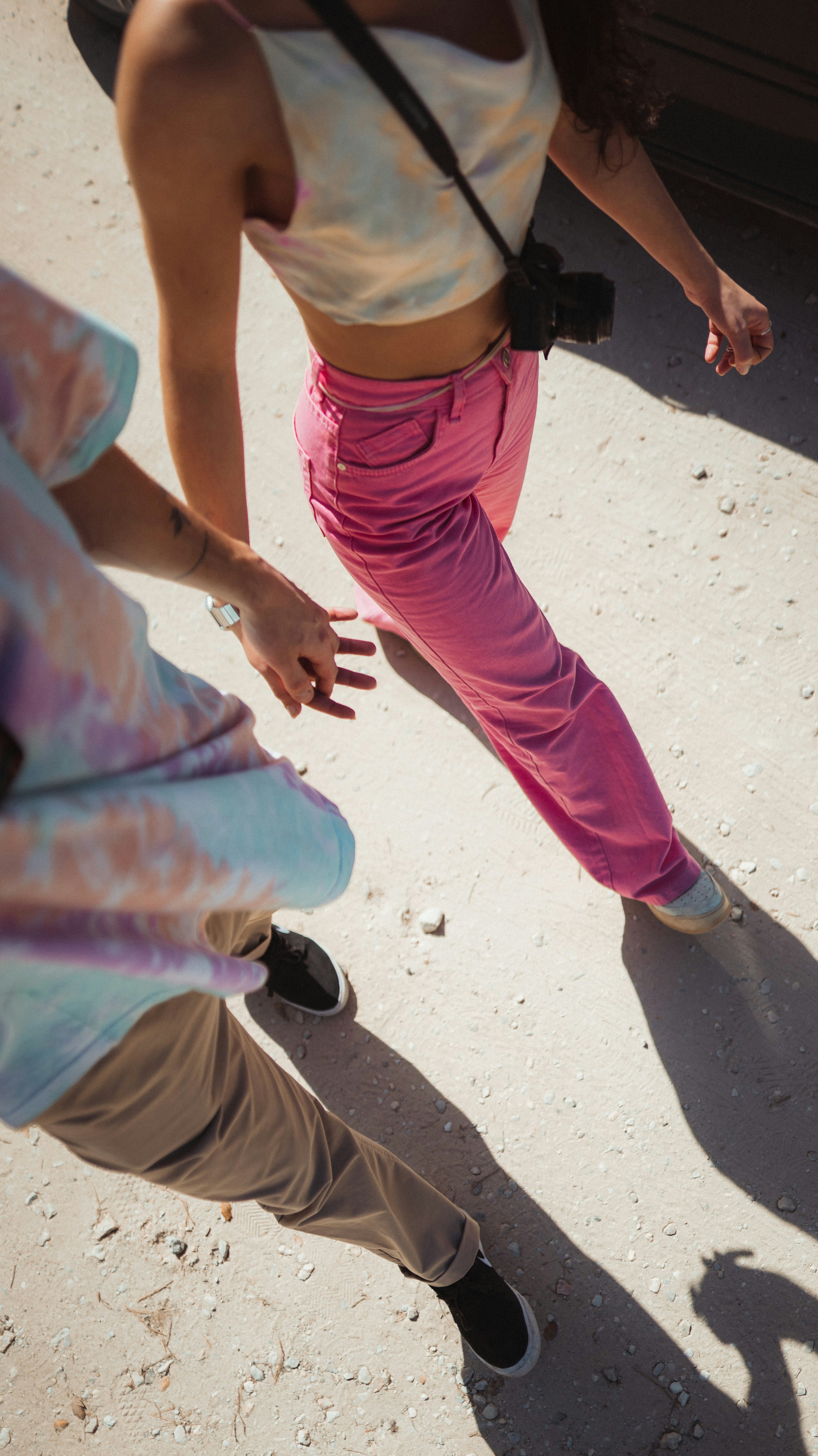 Overhead stride: pink pants and sunlit path