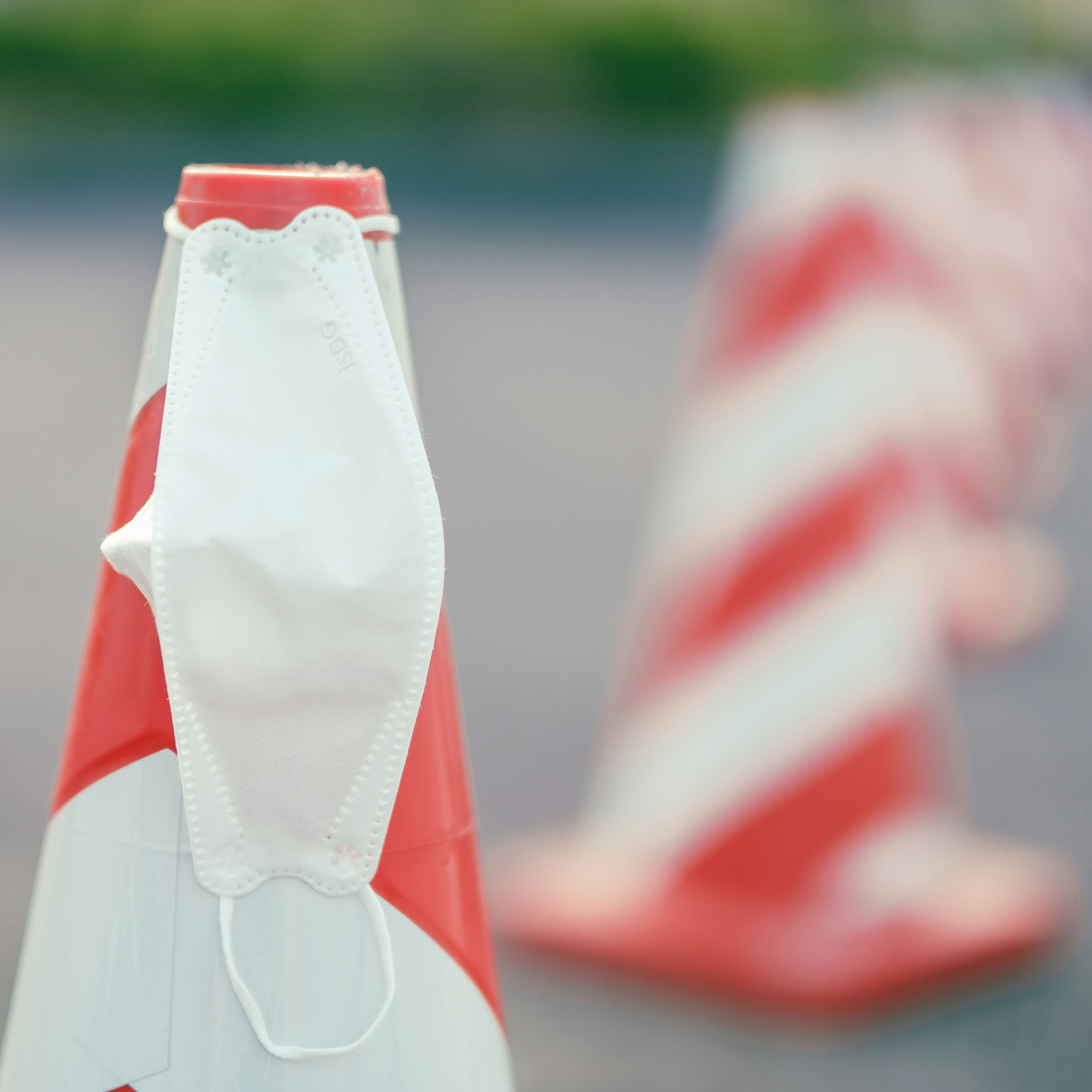 A red and white cone sitting on the side of a road photo – Free Cone ...