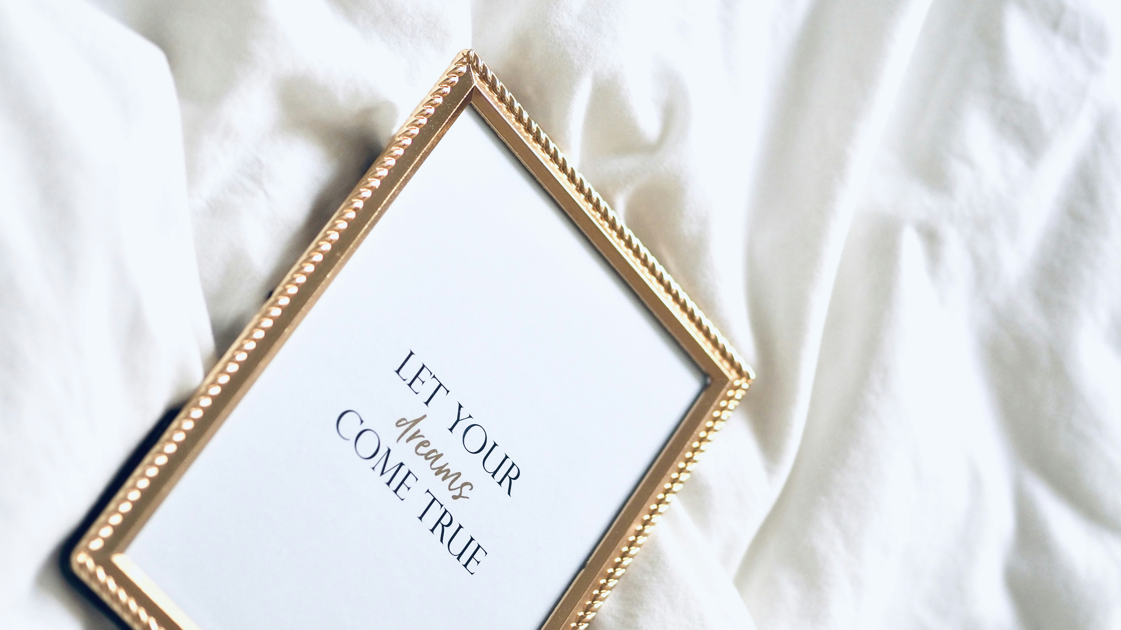 A picture frame sitting on top of a white sheet photo – Free Text Image ...