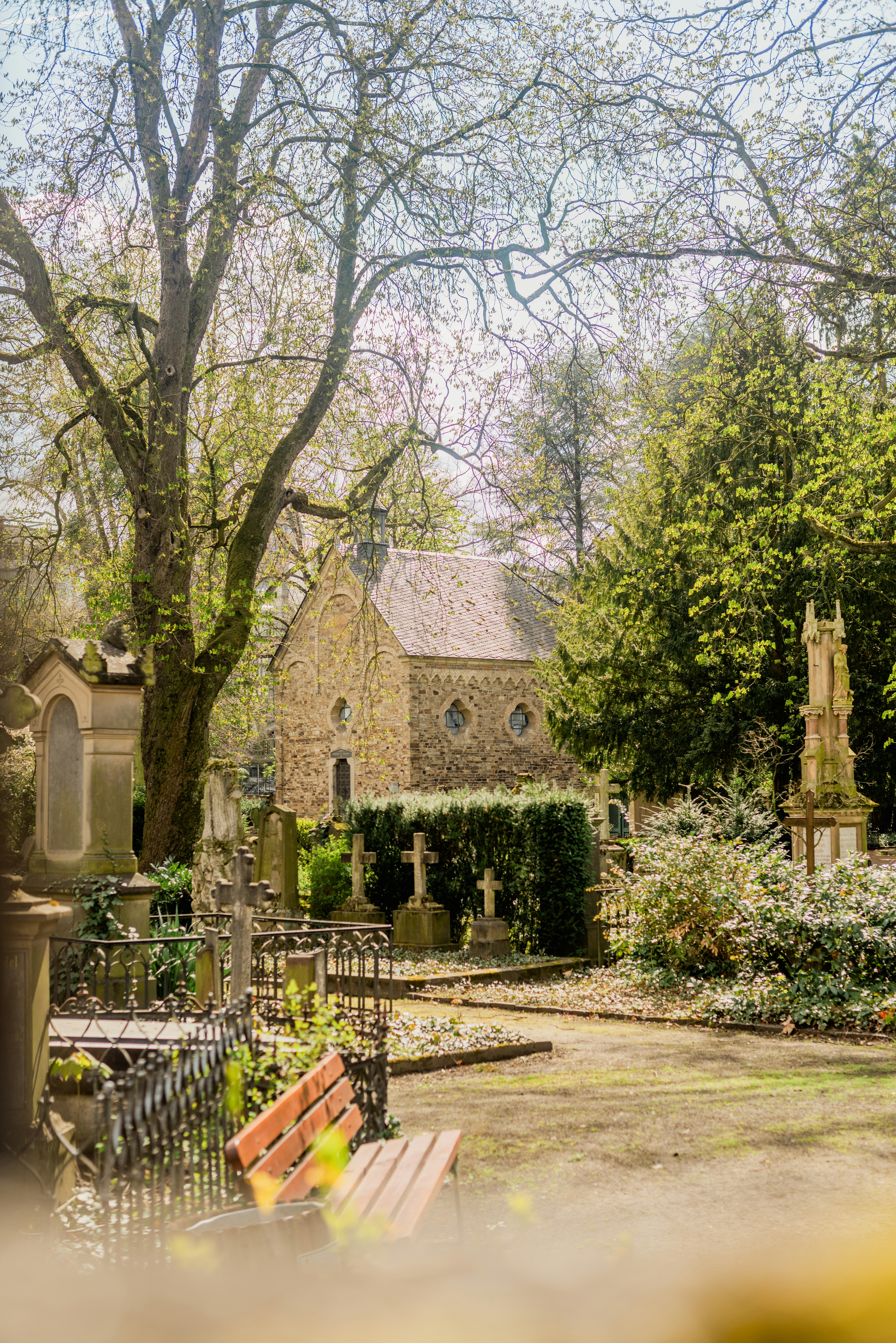 Stone Chapel Framed by Spring Foliage in a Quiet Cemetery