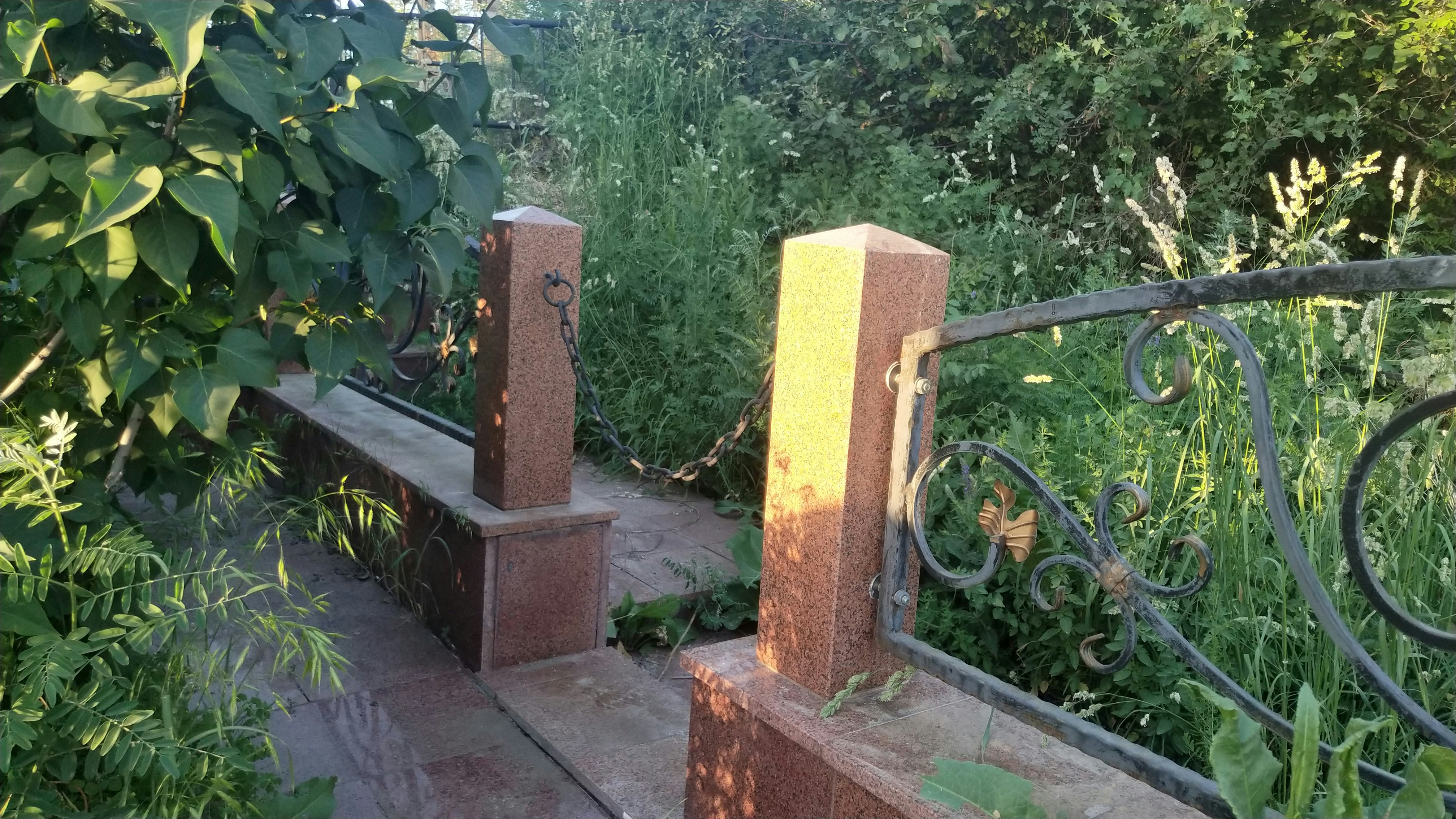 Sunlit Stone Posts Framing a Quiet Garden Path