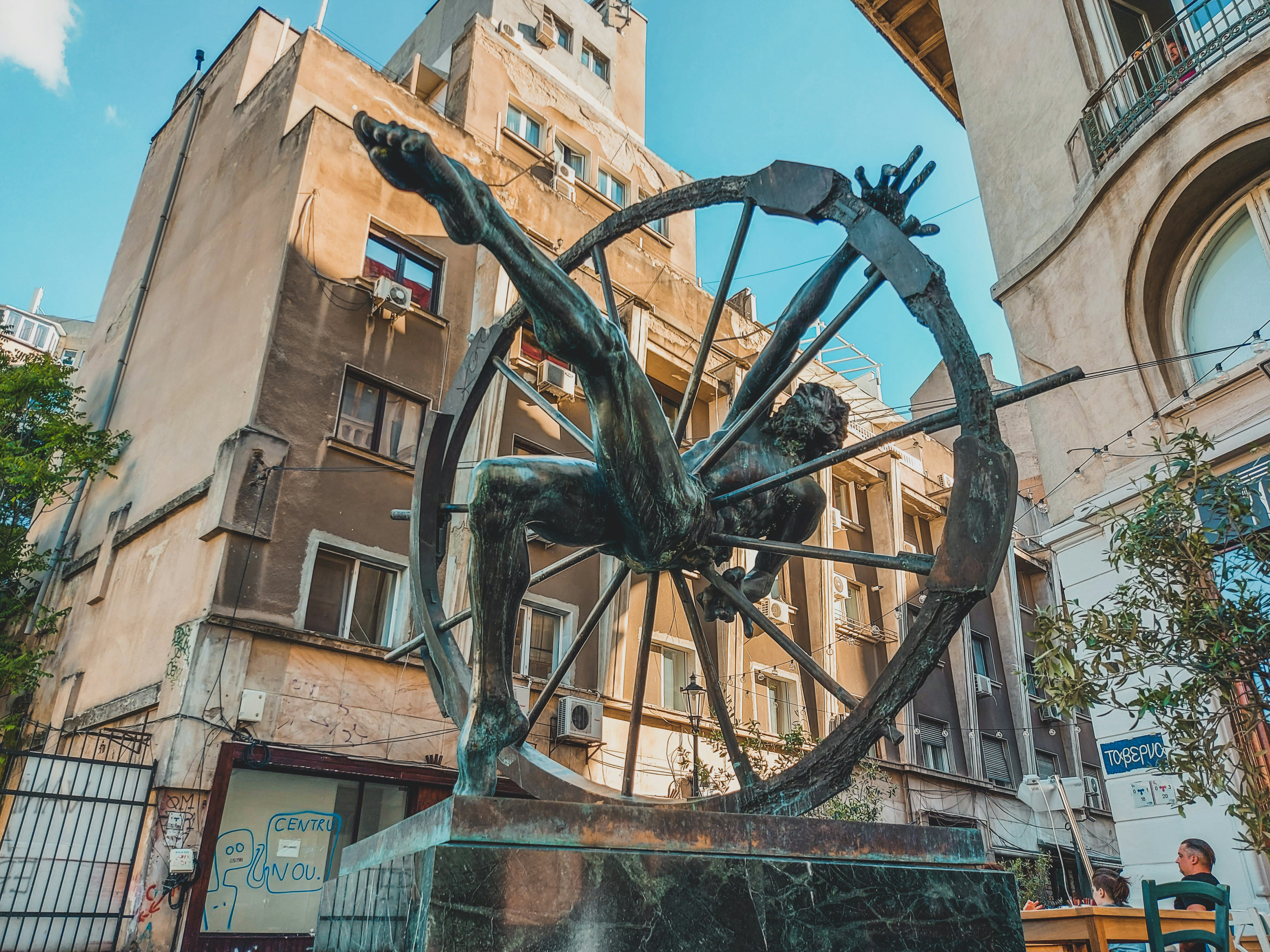 Rotating Monolith: A Sculpted Figure in Motion Reaching Toward the Sky