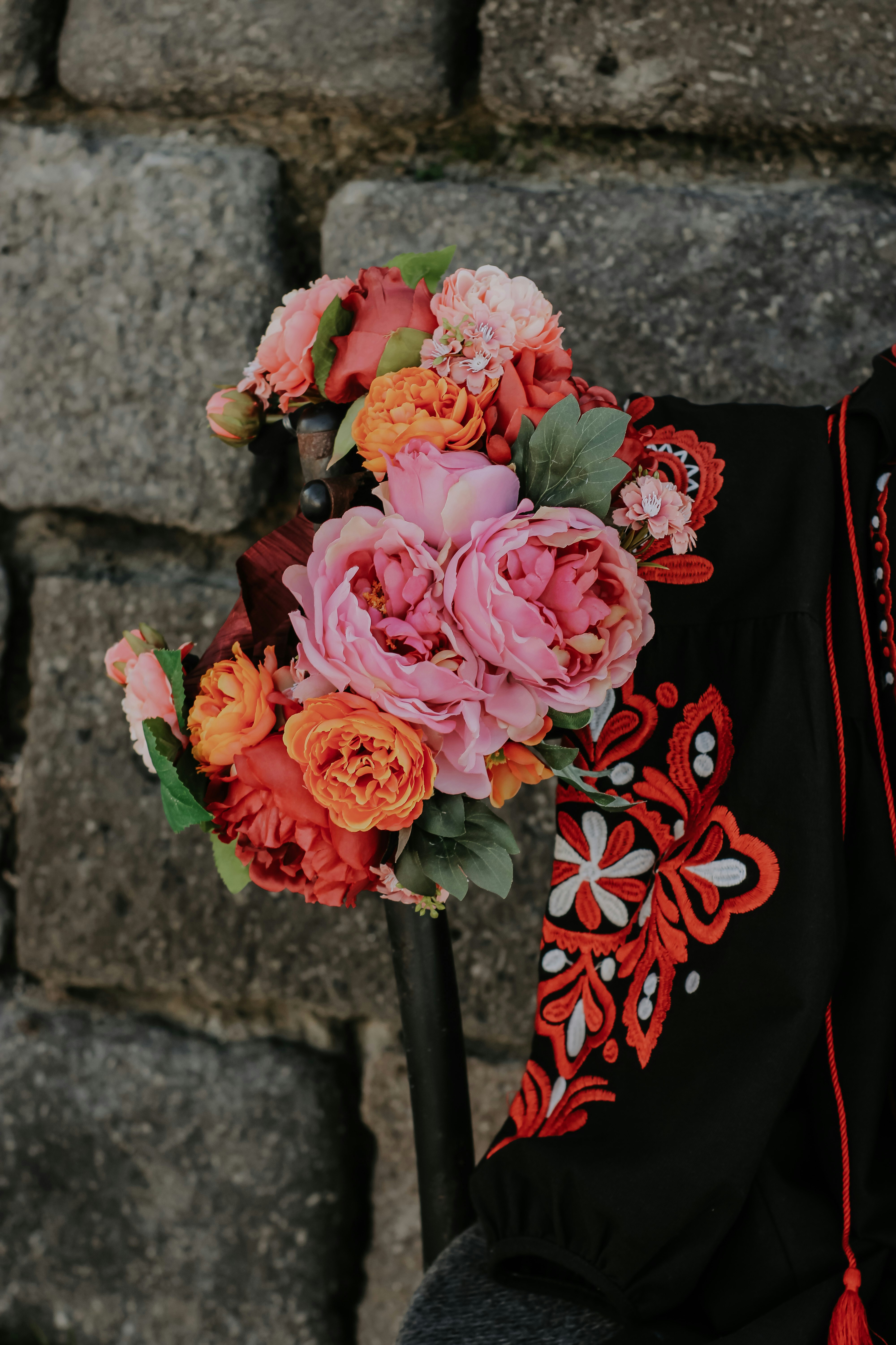 Petals Against Stone: A vibrant bouquet cradled by embroidered black fabric