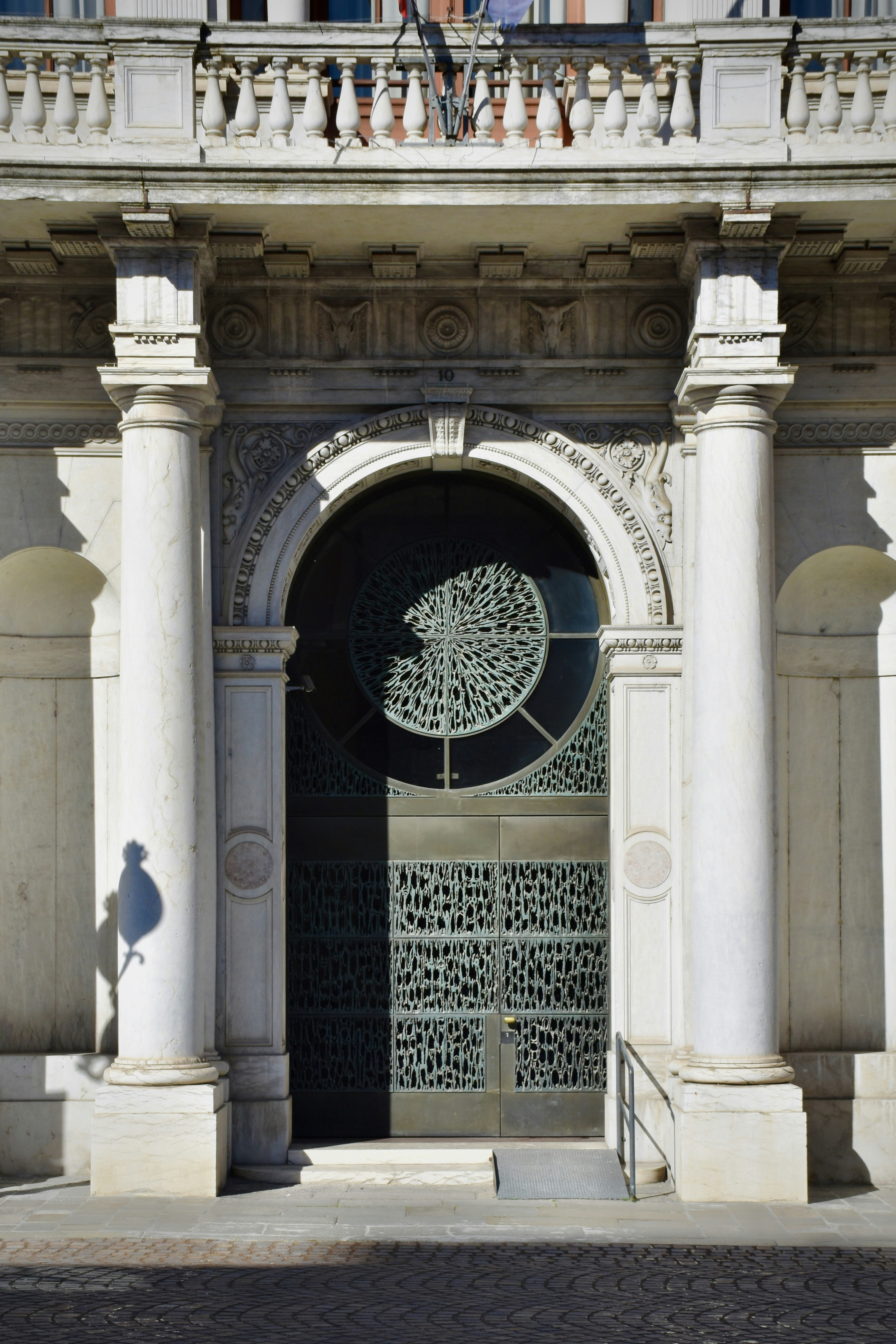 A tall building with a large metal door photo – Free Ferrara Image on ...