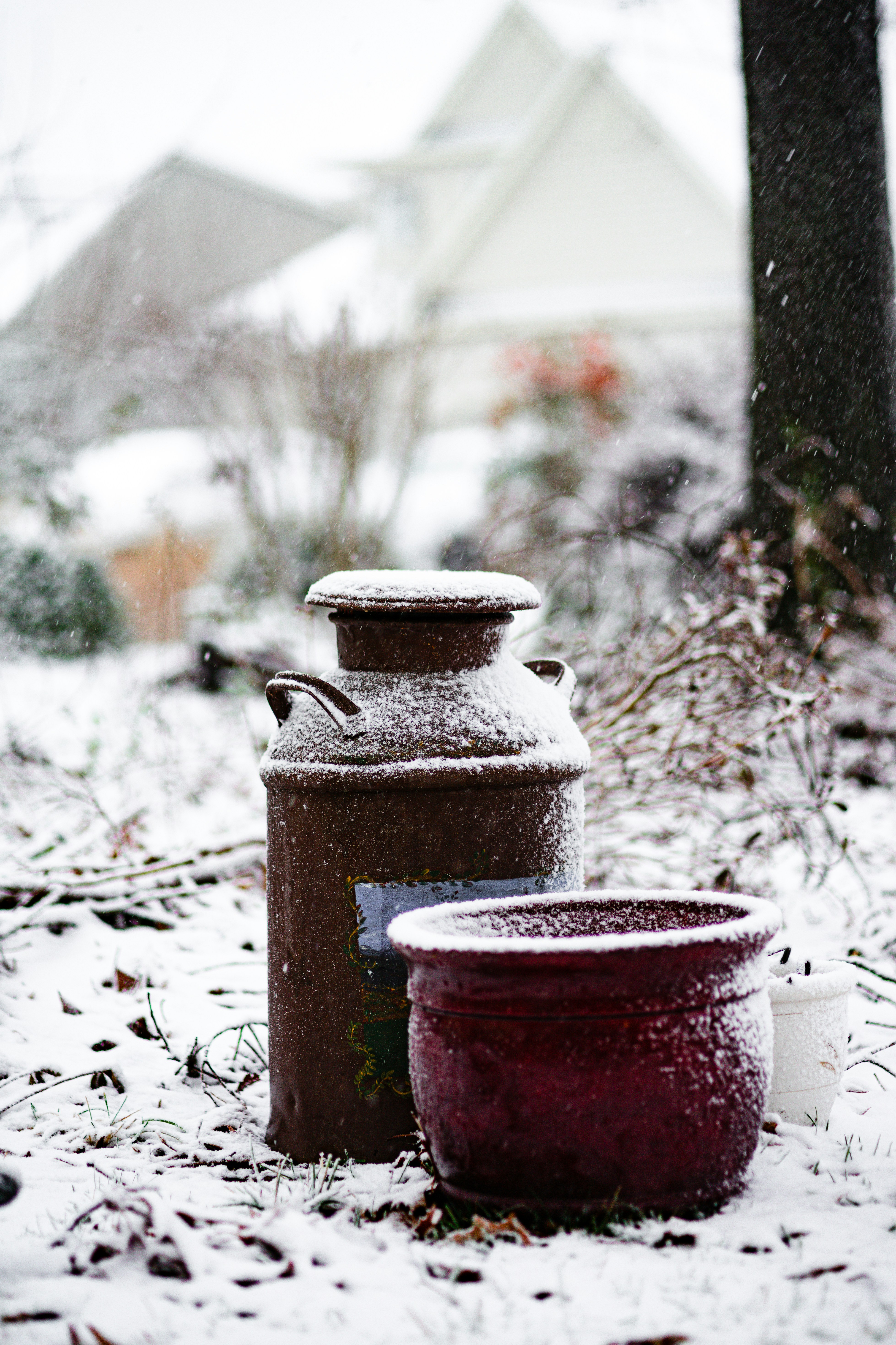 A couple of pots sitting on top of a snow covered ground photo – Free ...