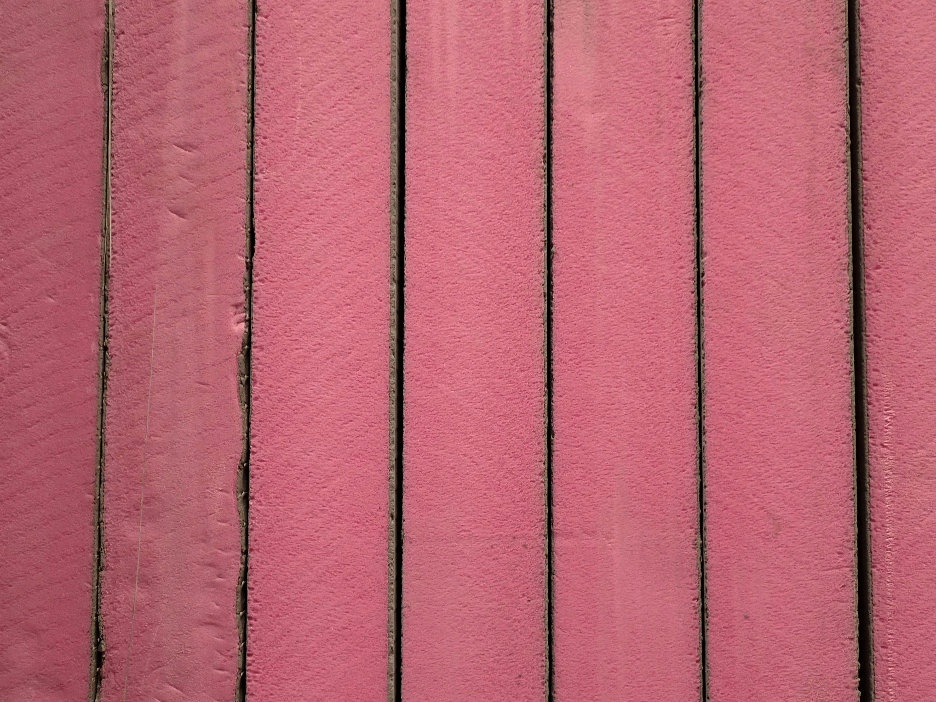 Vertical panels of textured pink material create a striking visual pattern, emphasizing depth and dimension.
