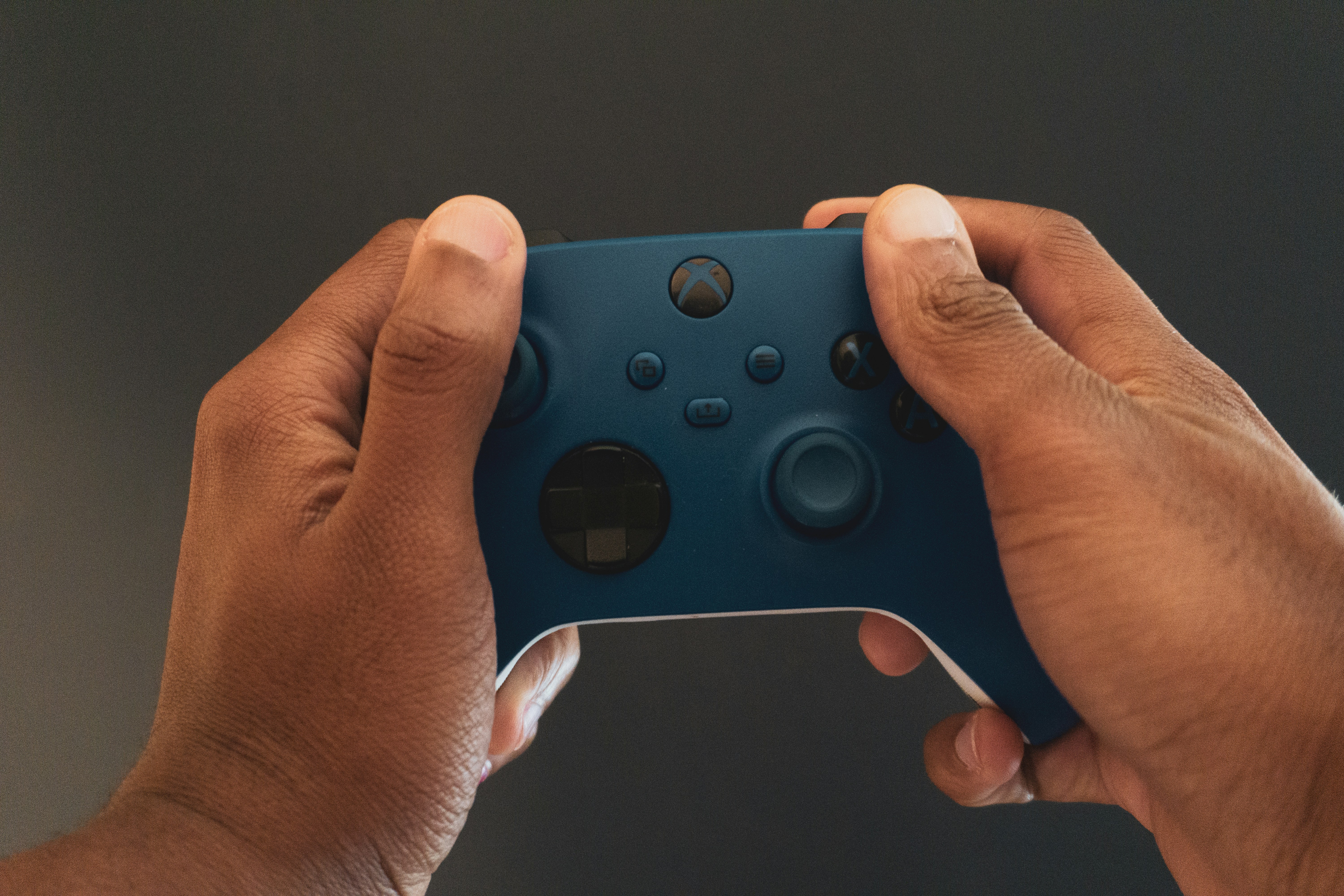 a close up of a person holding a nintendo wii controller