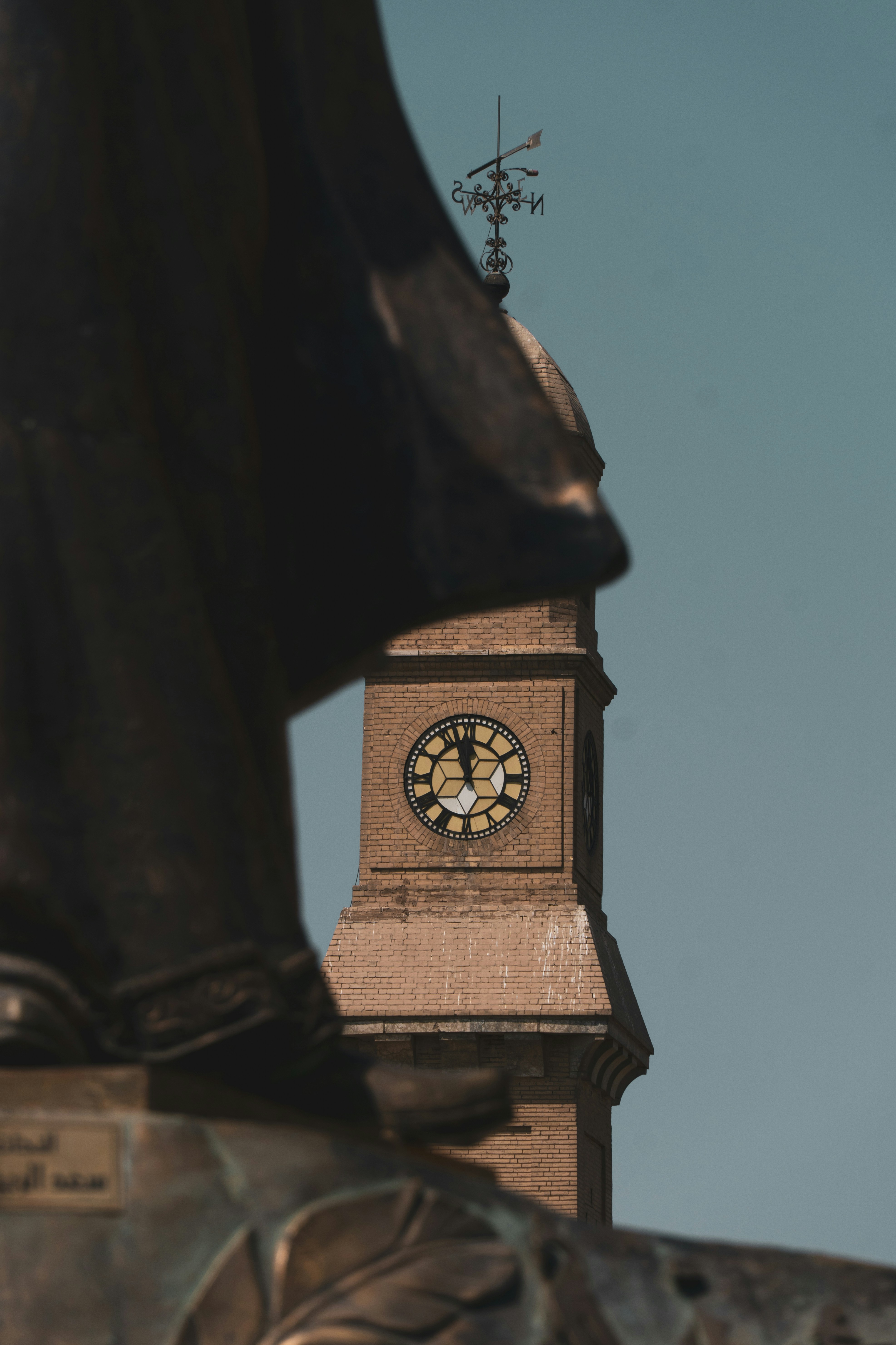 A statue of a man with a clock on his face photo – Free Grey Image on ...