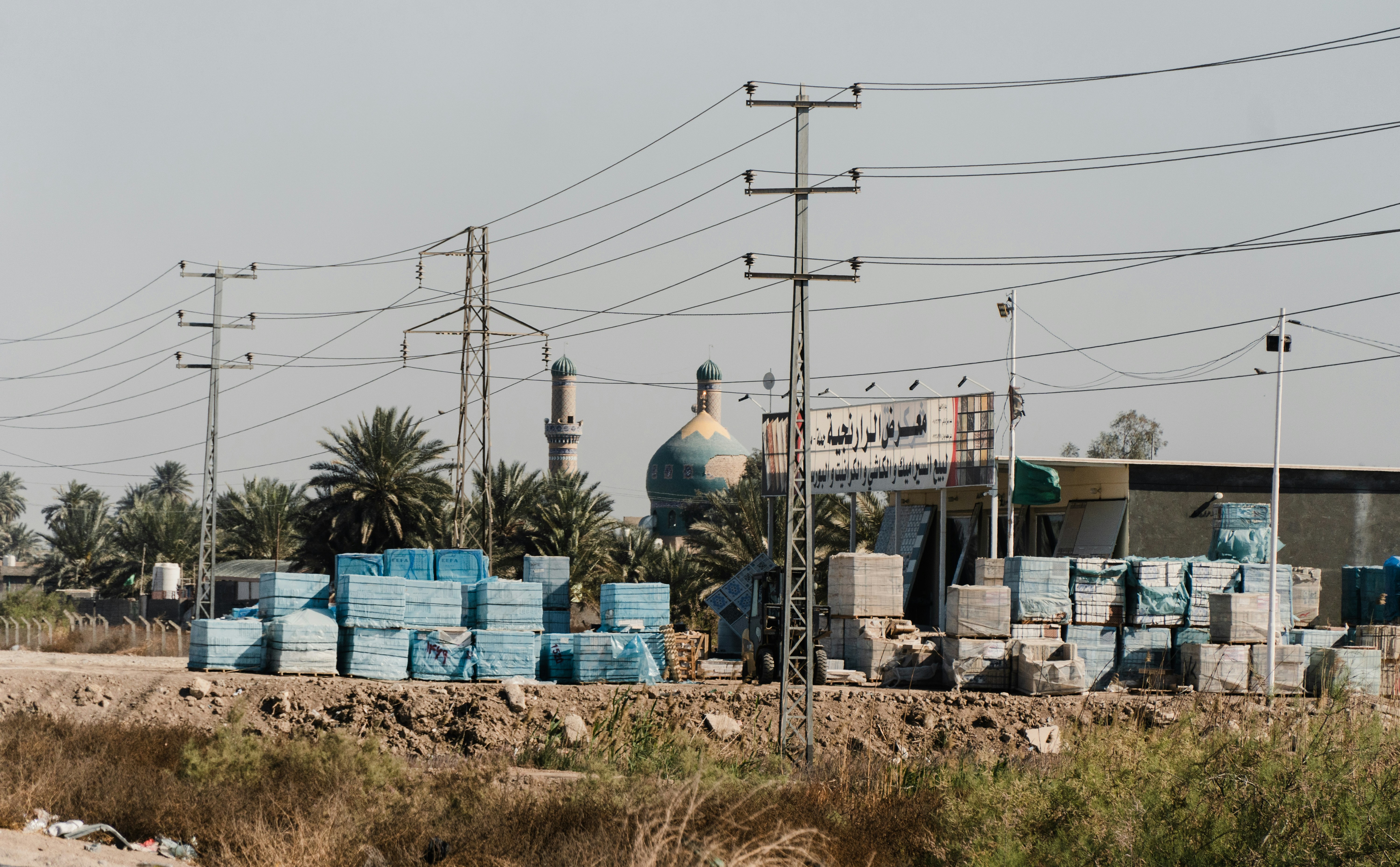 a bunch of blue boxes sitting on the side of a road