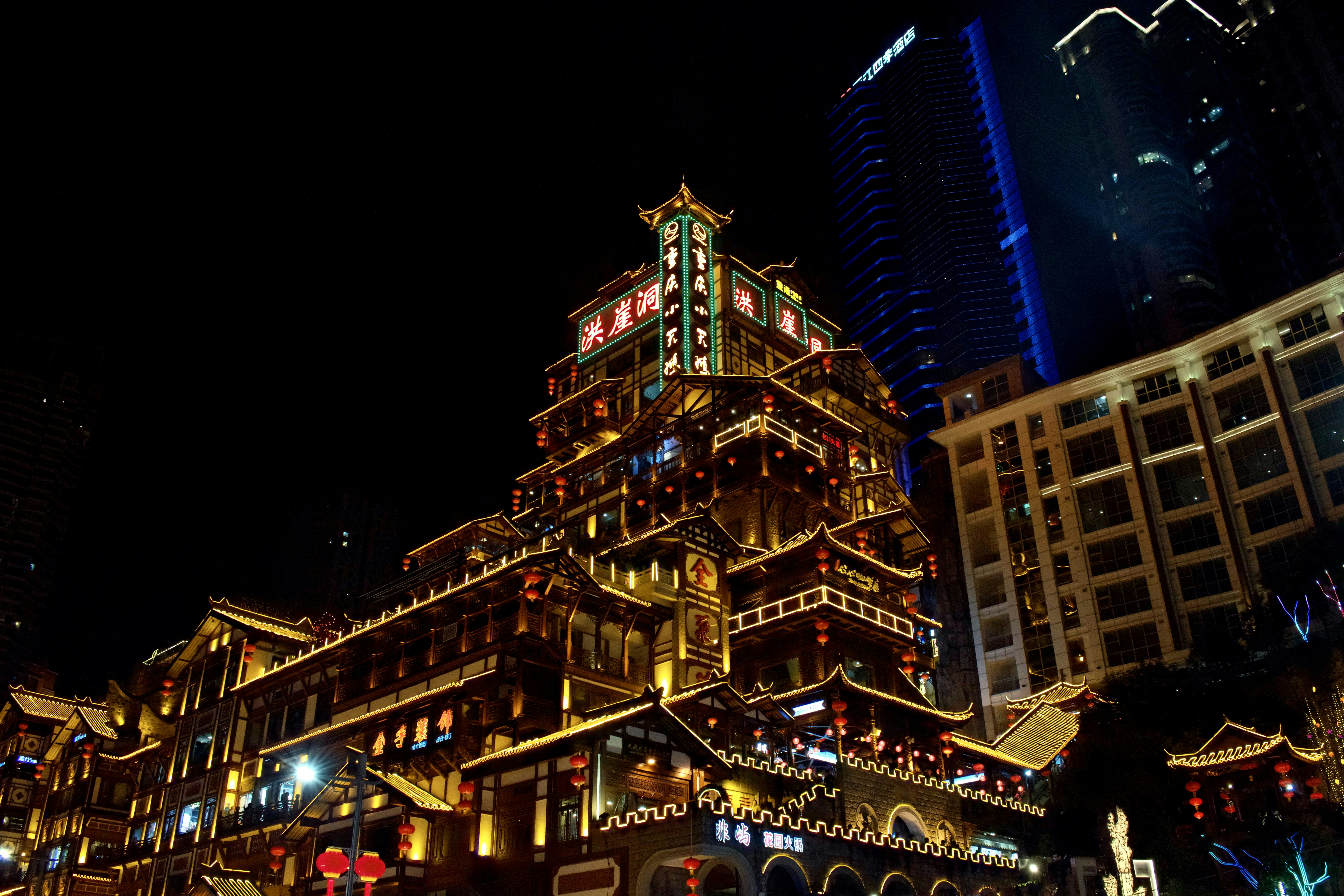 A very tall building with a lot of lights on it photo – Free Chongqing ...