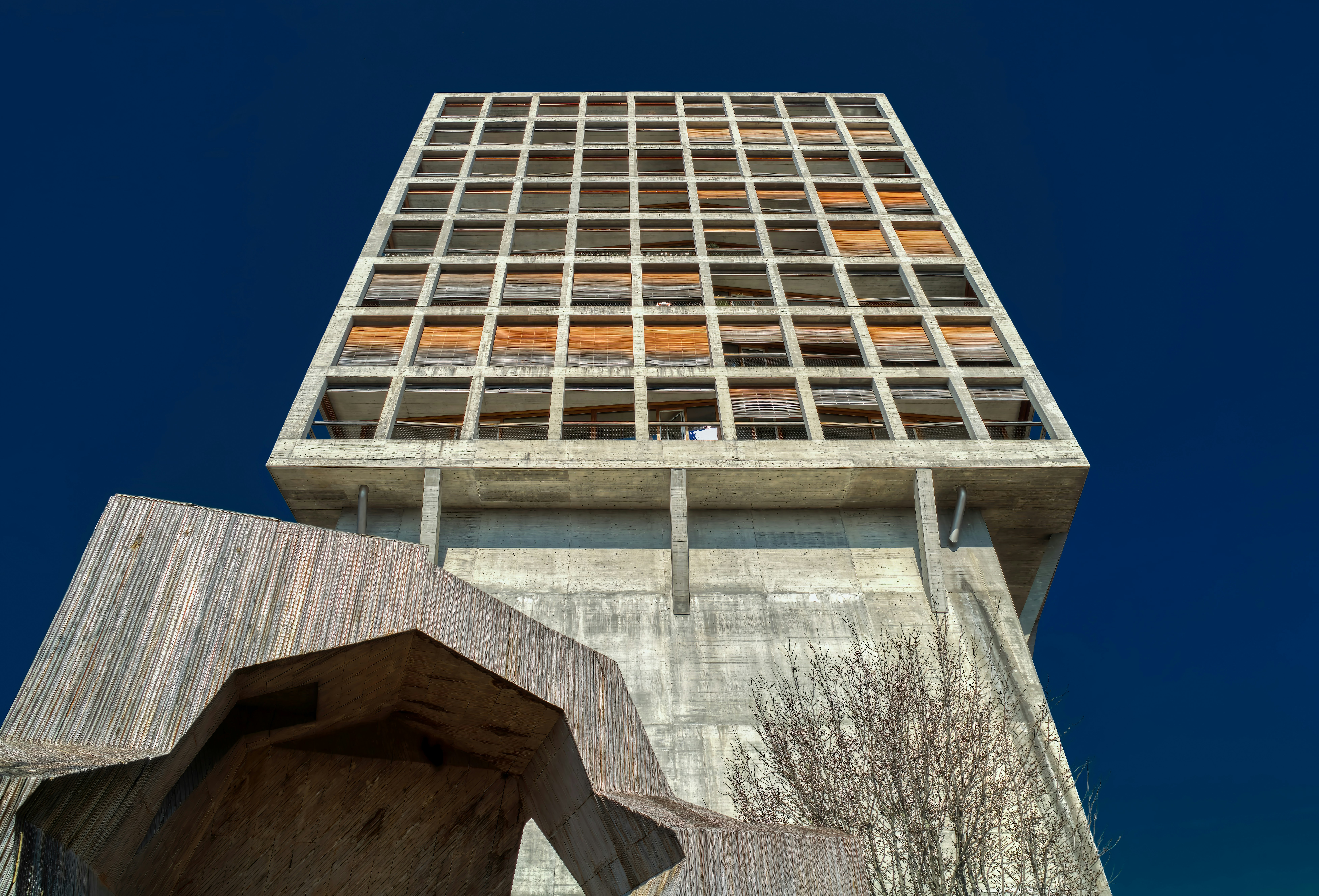 Grid-Window Monolith Rising Under a Cobalt Sky