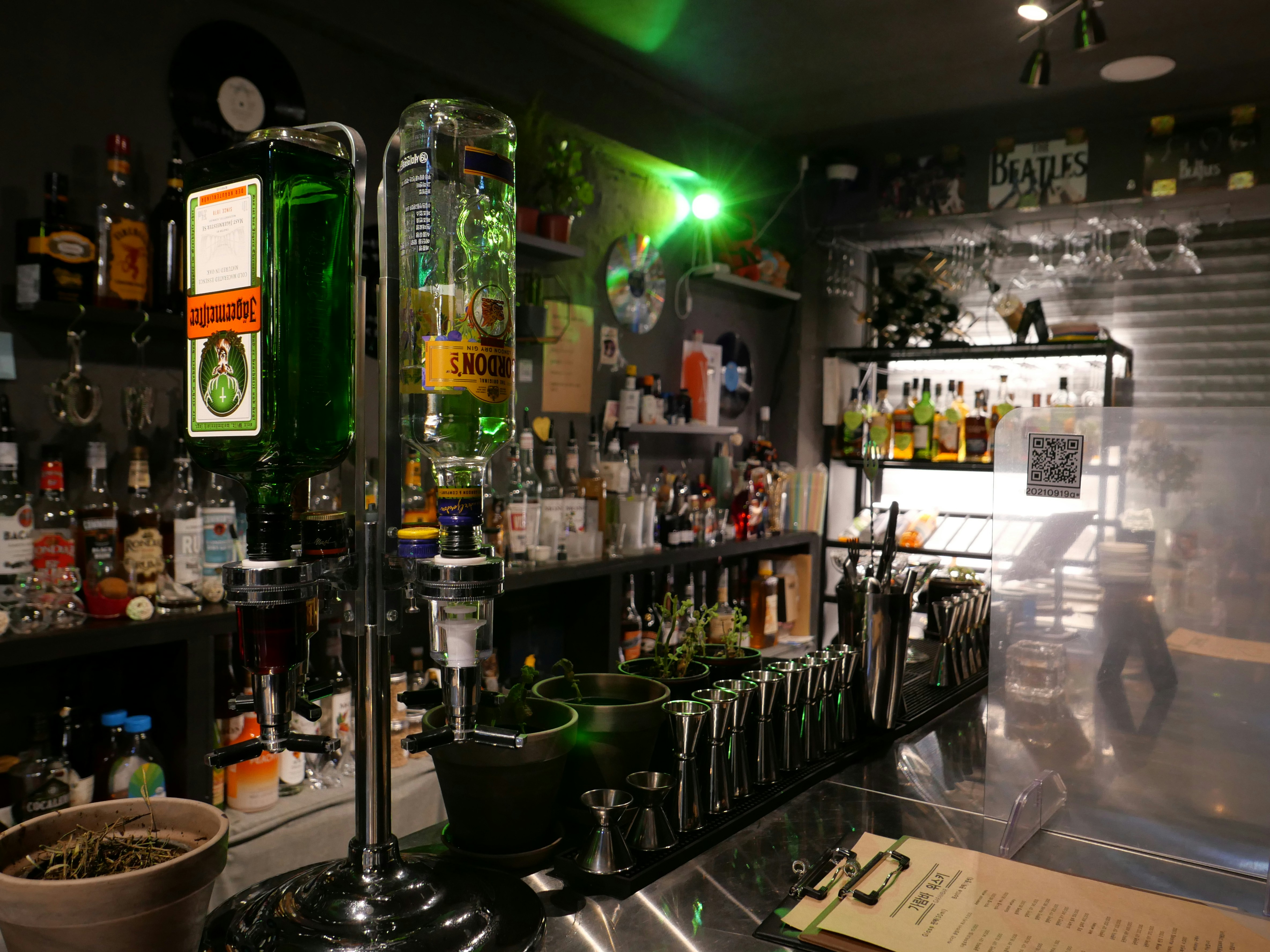 A bar filled with lots of bottles of alcohol photo – Free Bottle Image ...