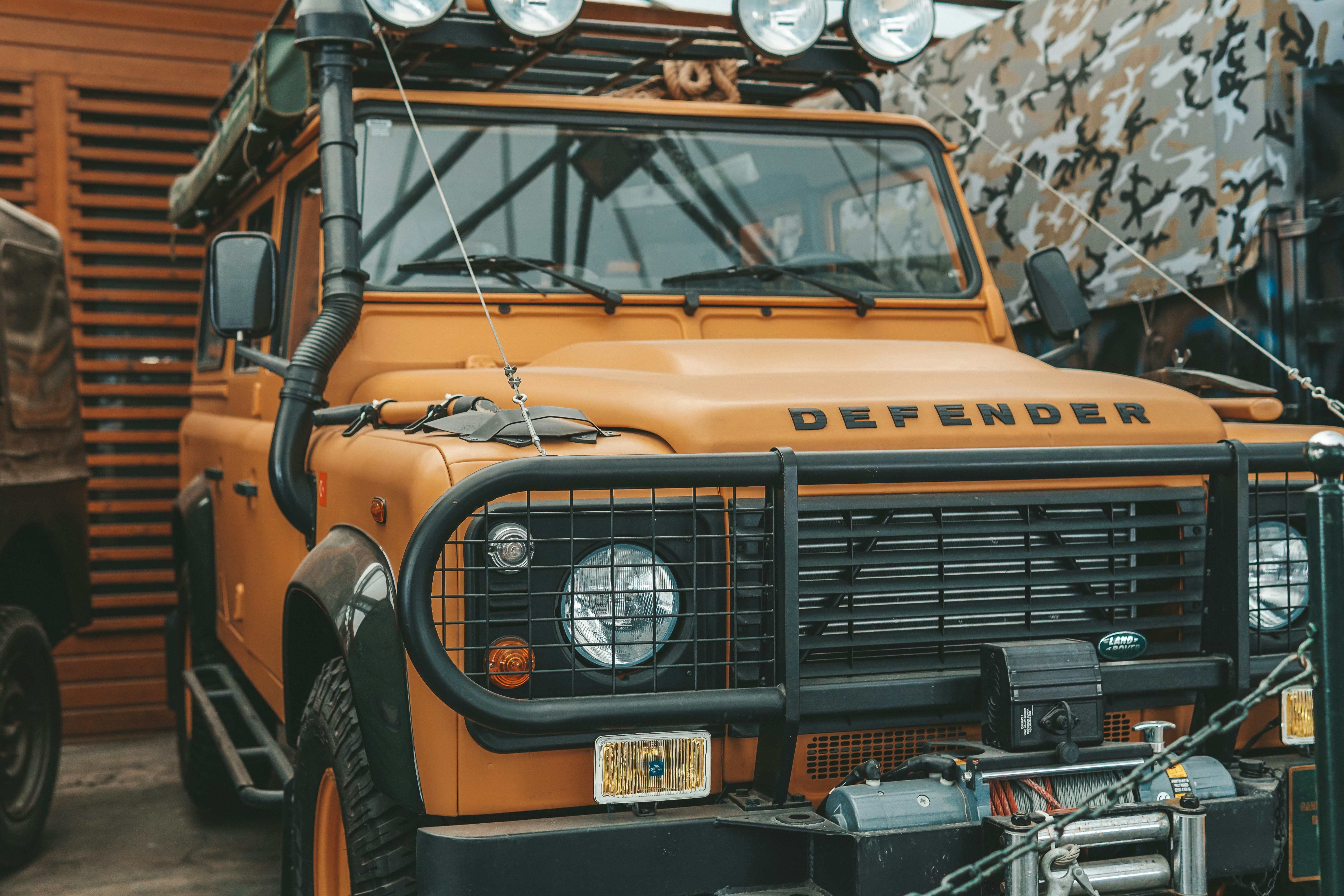 An orange defender truck parked in a garage photo – Free Haliç Image on ...