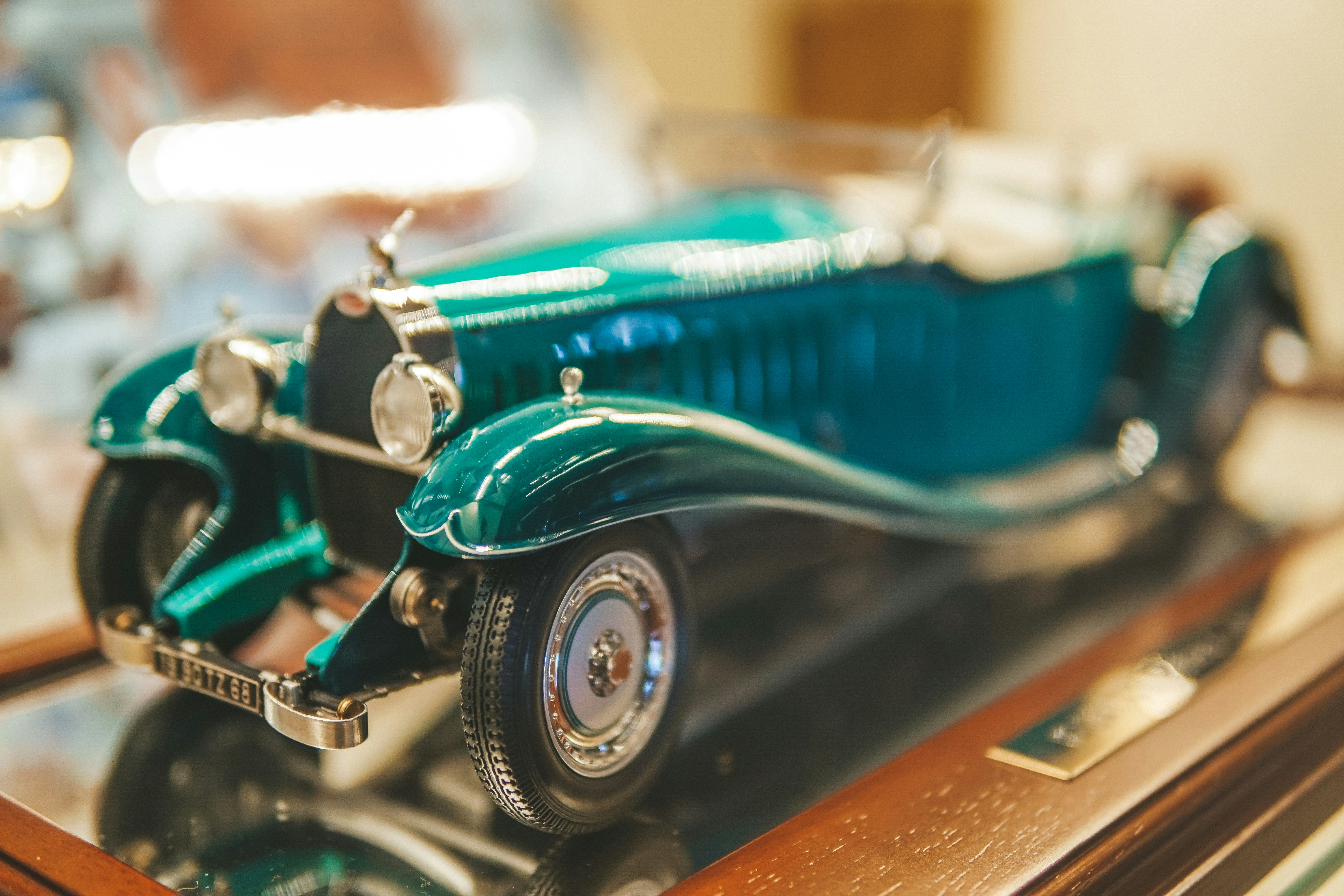 Teal Thunder in Glass: A Tiny Vintage Car Model On Display