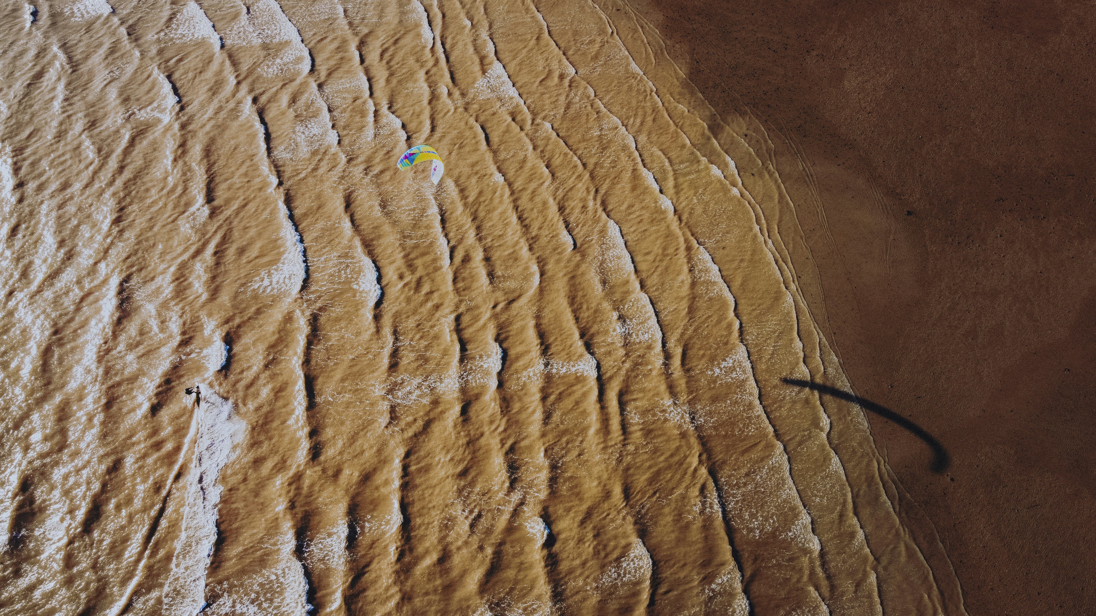 Brown water on kitesurfing session shot from a drone.