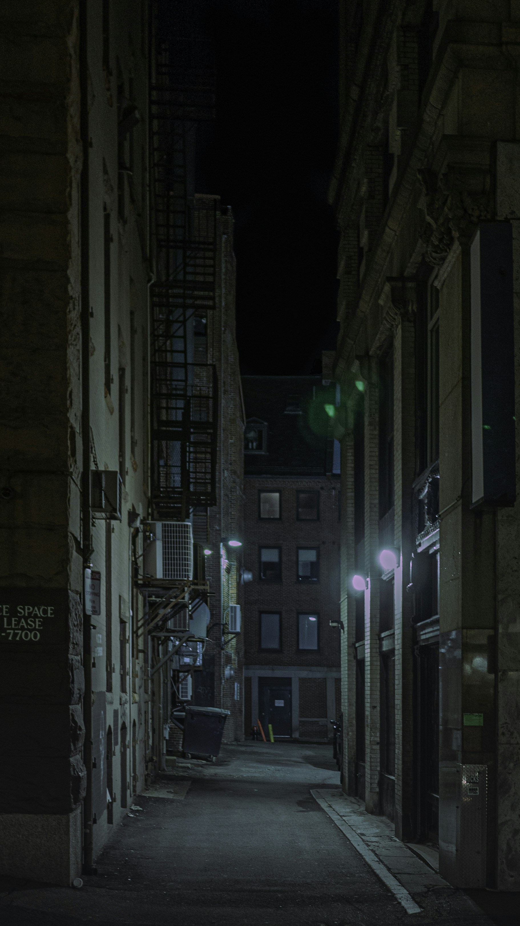 A dark alley way with buildings and a street light photo – Free Boston ...