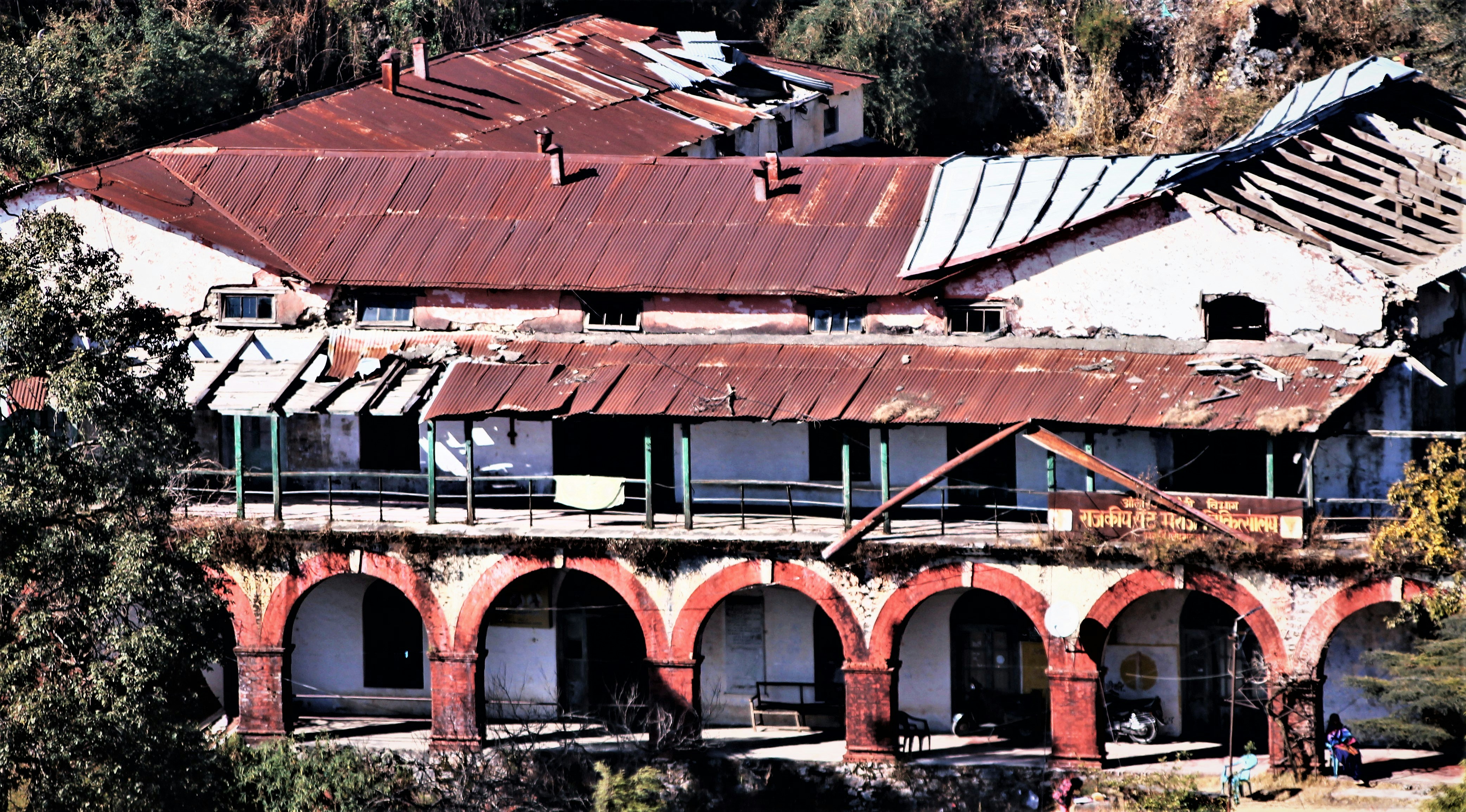 Rusted Roofs and Red Arches: A Sunlit Industrial Decay