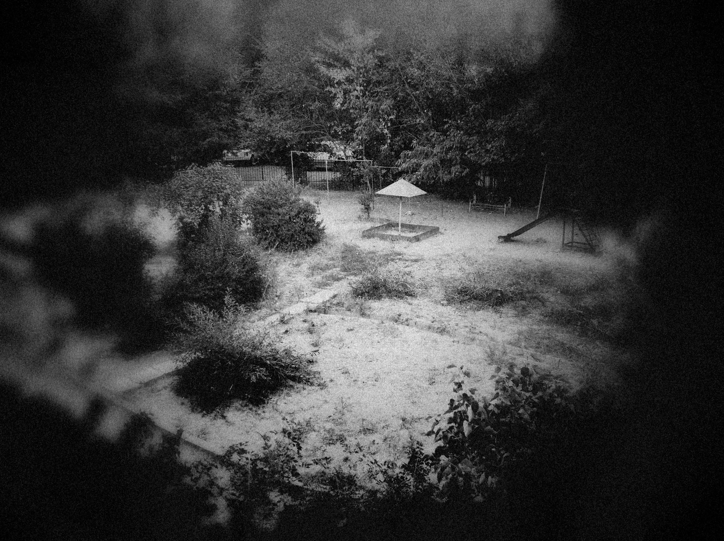 a black and white photo of a dirt field