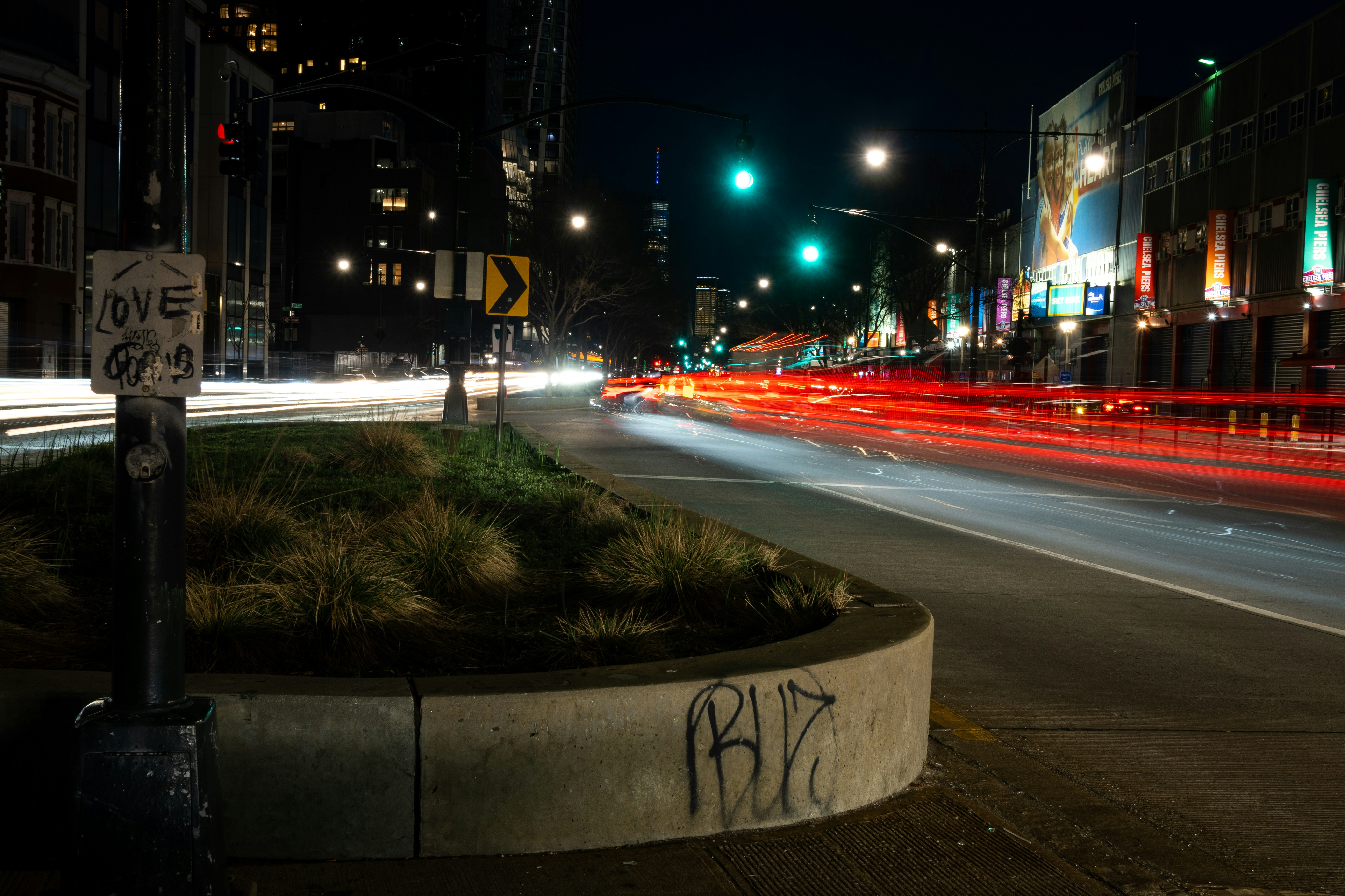 Green Signal at the Curve: Night Roundabout with Red Light Trails