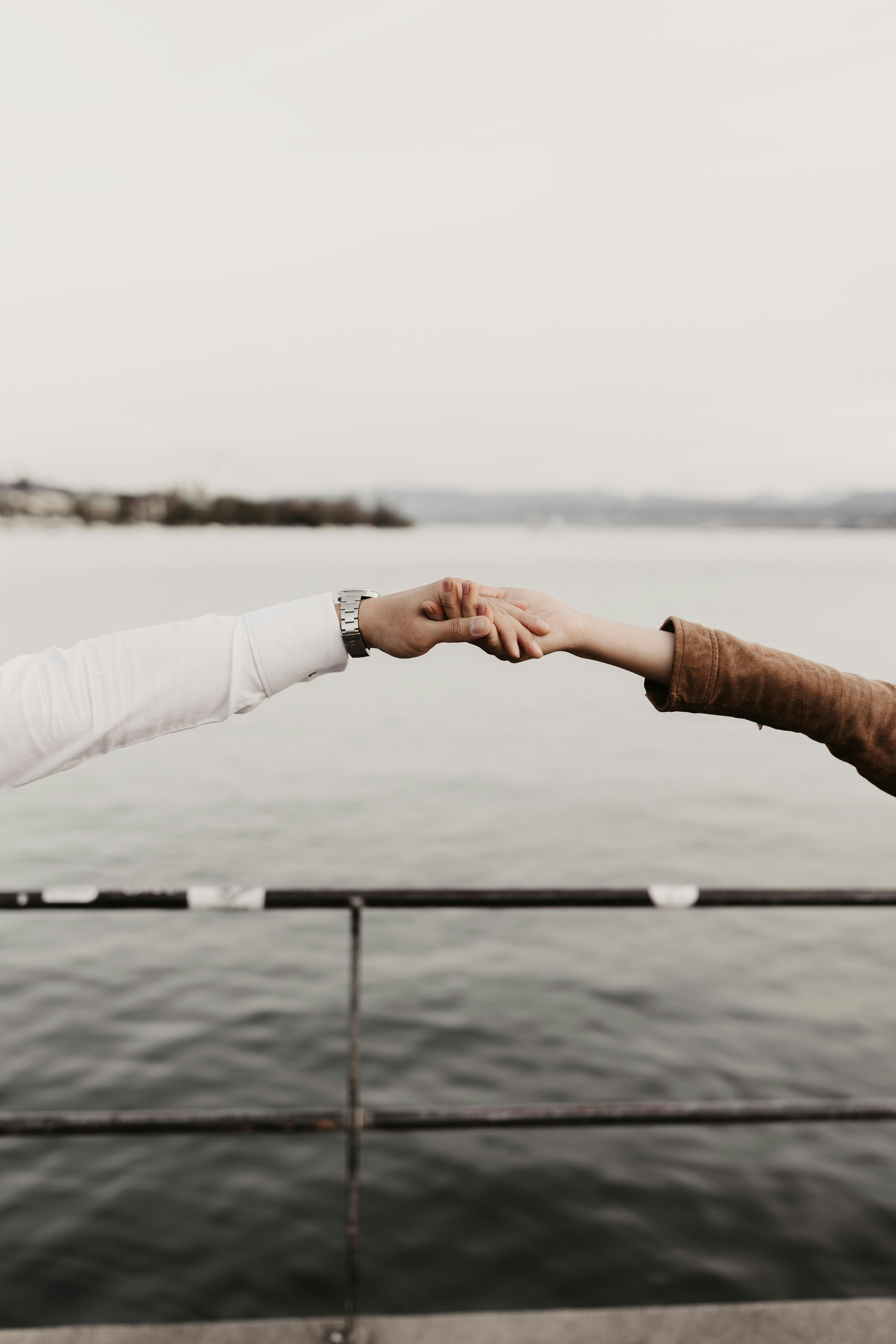 Two people reaching out their hands to each other photo – Free Grey ...