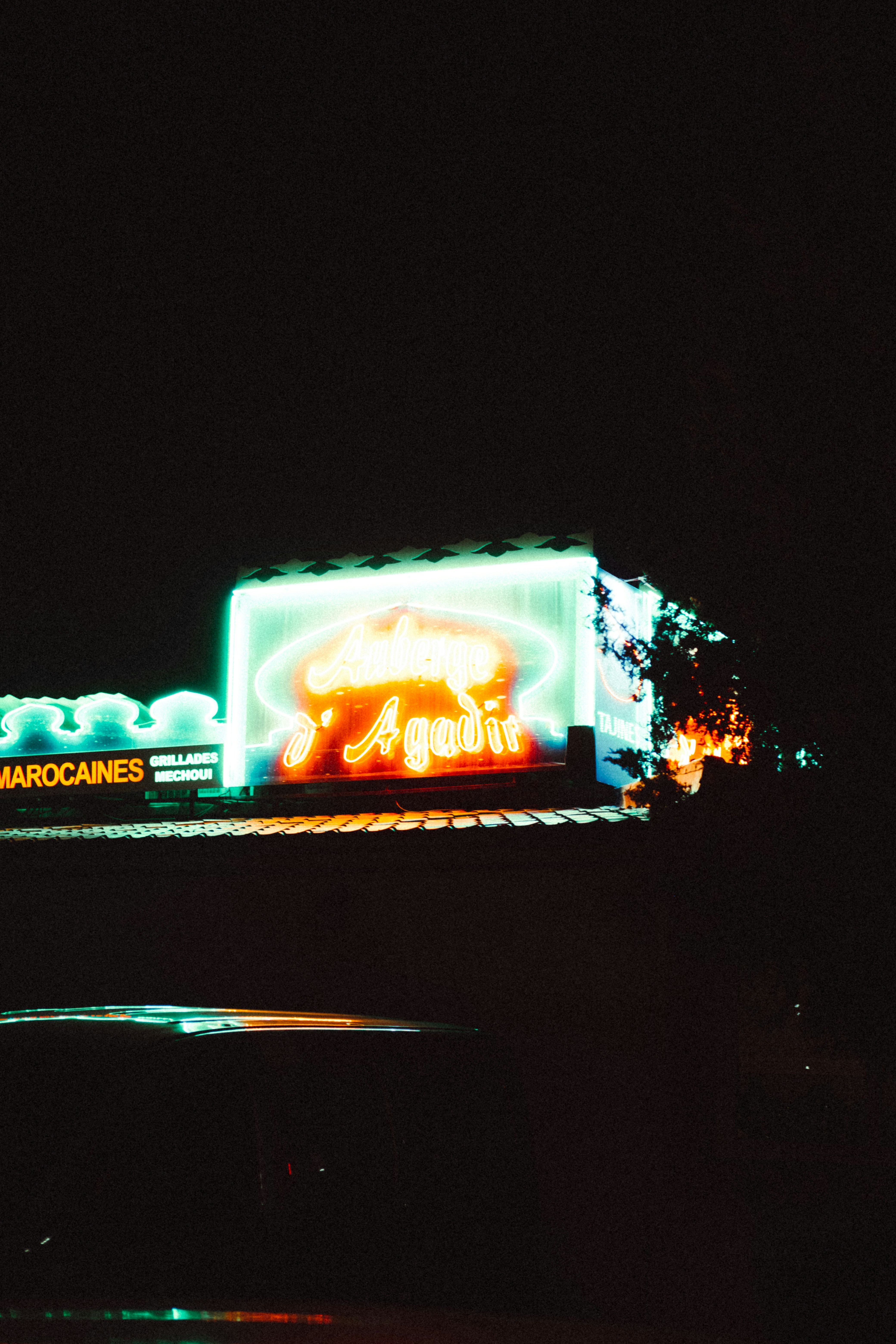 a neon sign is lit up in the dark