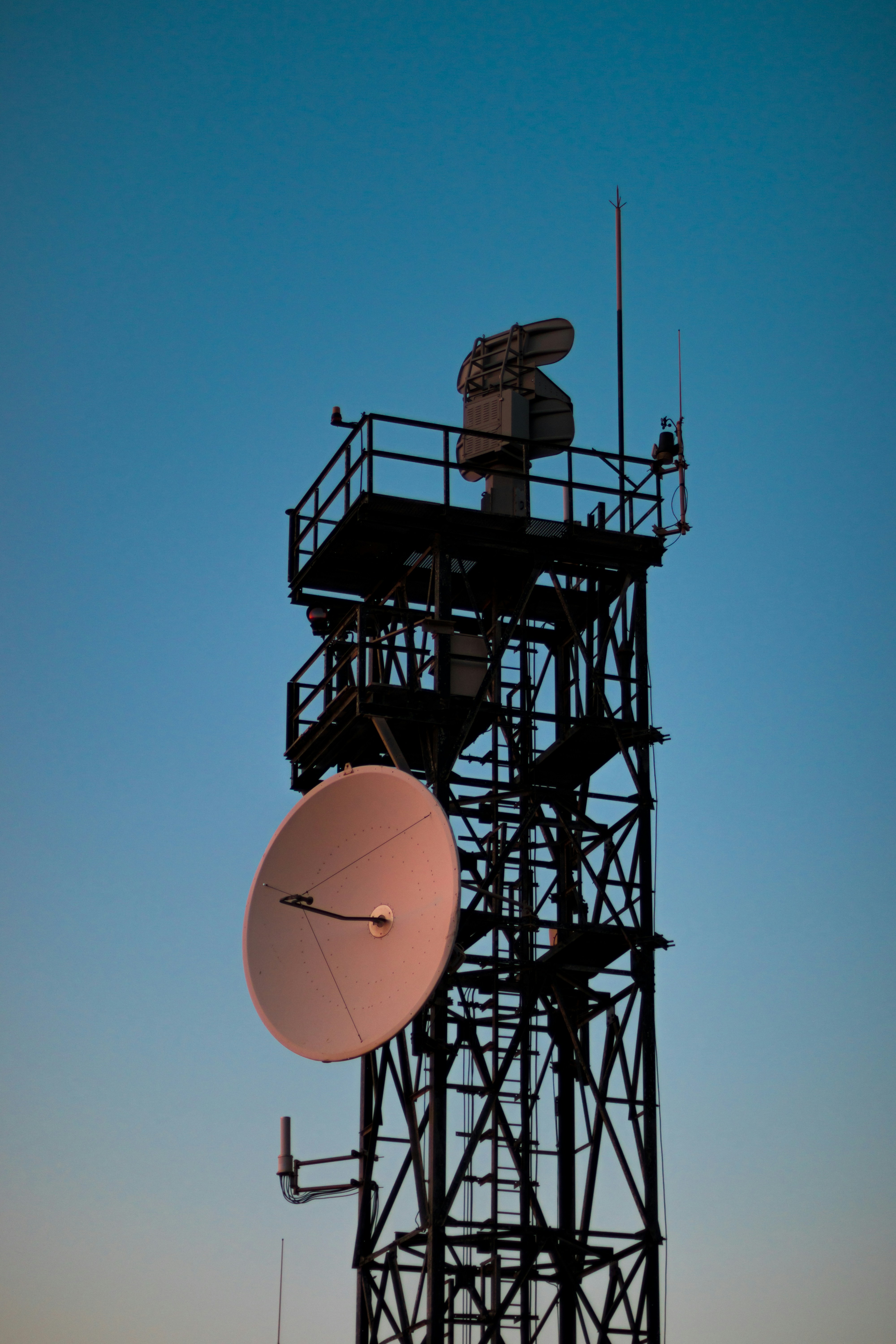 A very tall tower with a satellite dish on top of it photo – Free ...