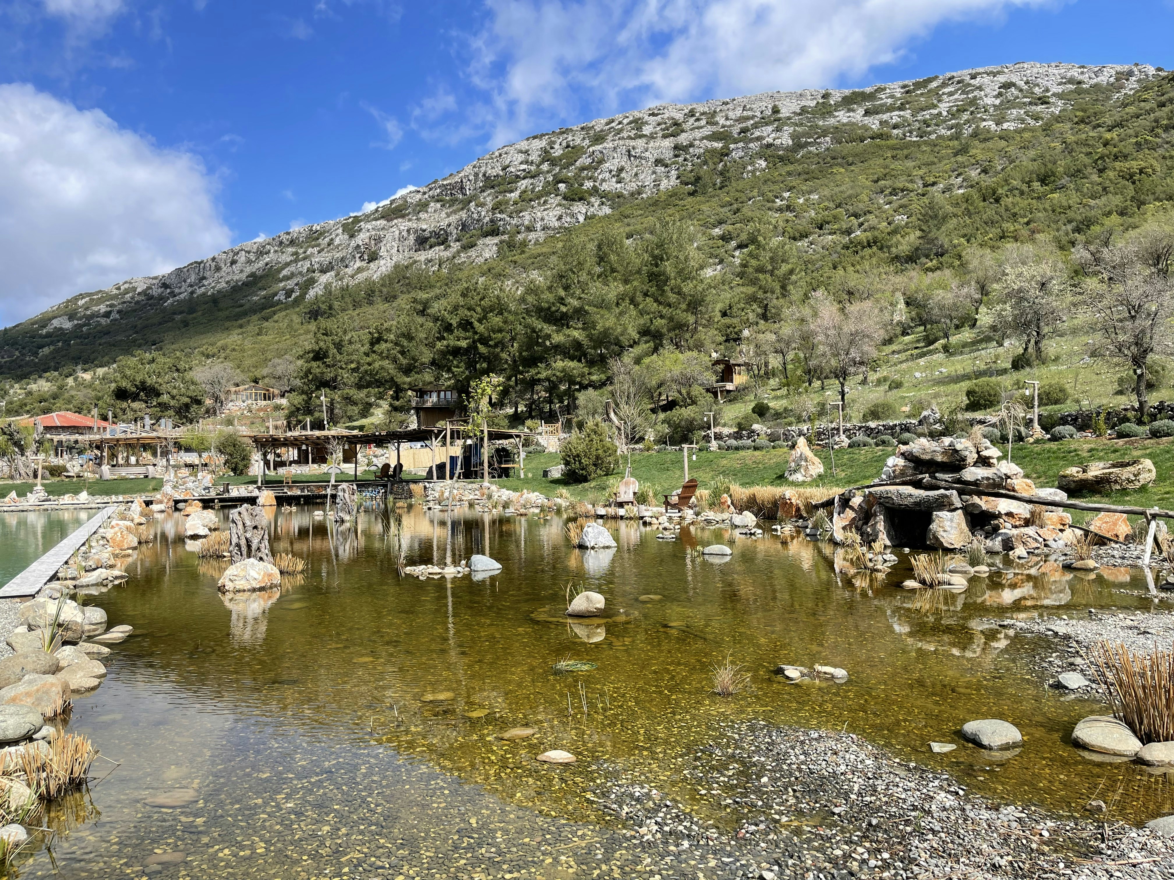 A small pond surrounded by rocks and grass photo – Free Turkey Image on ...