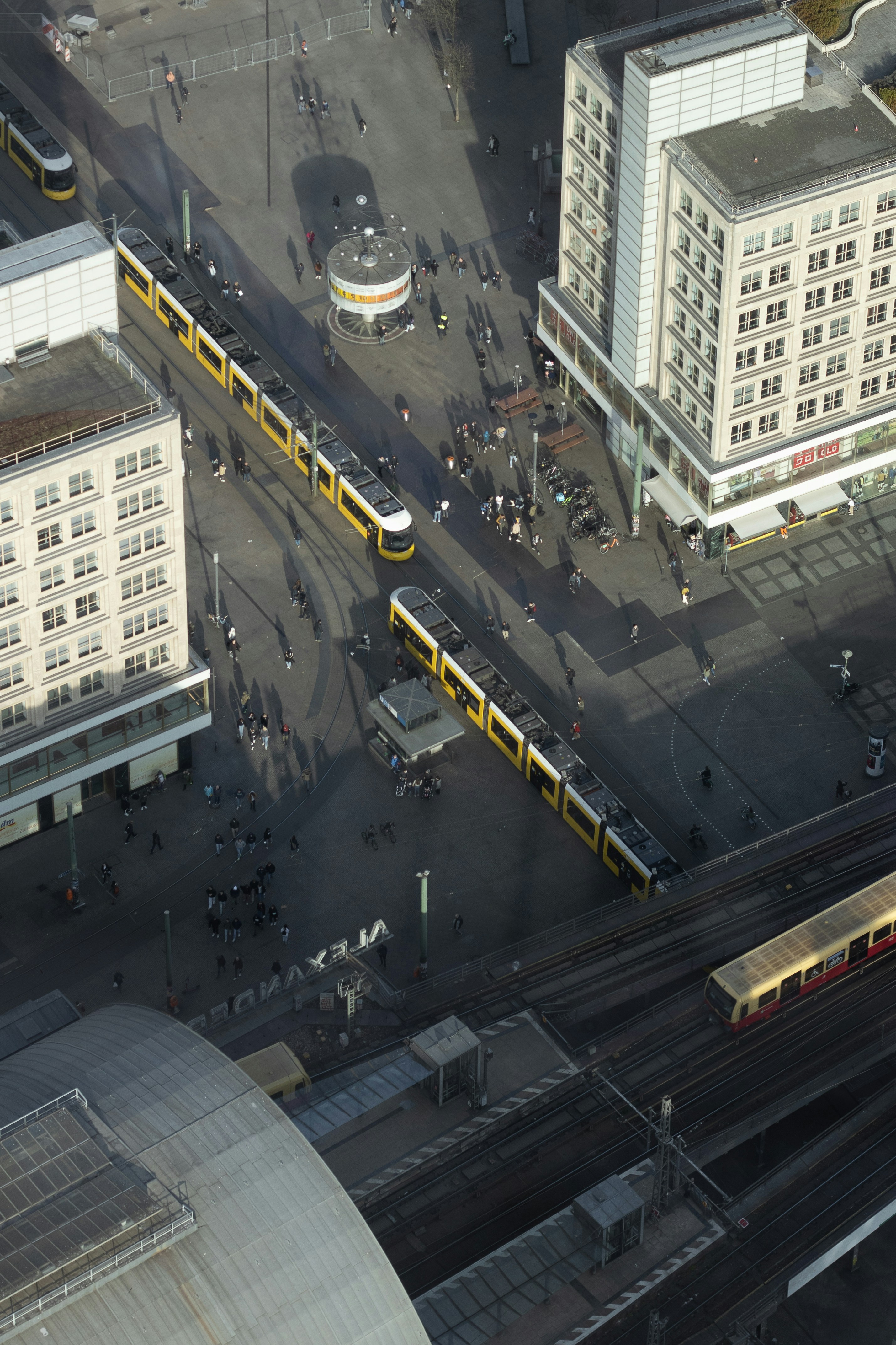 Aerial Crossroads: Yellow Trams Winding Through a City Grid