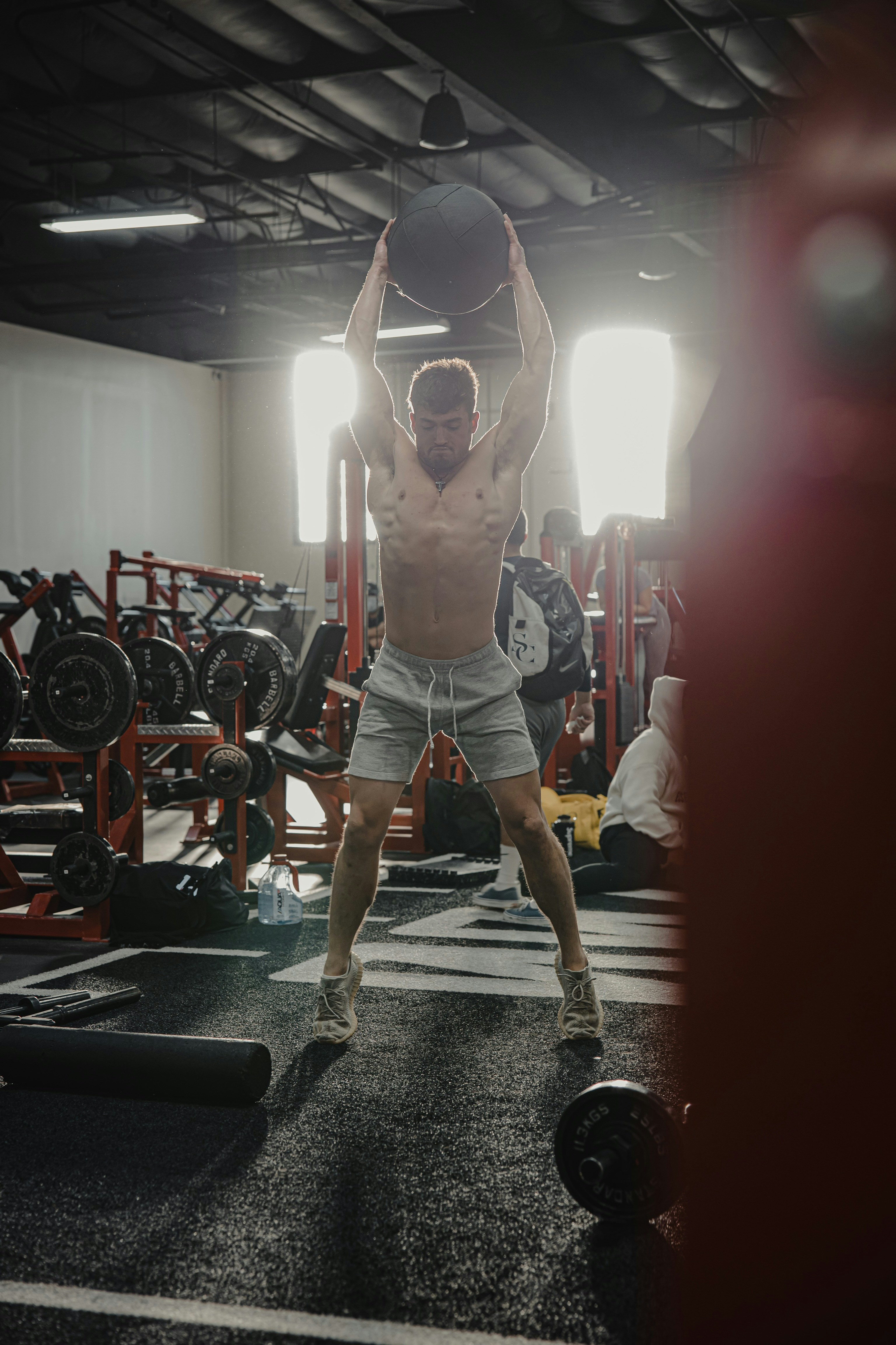 A man lifting a weight in a gym photo – Free Grey Image on Unsplash