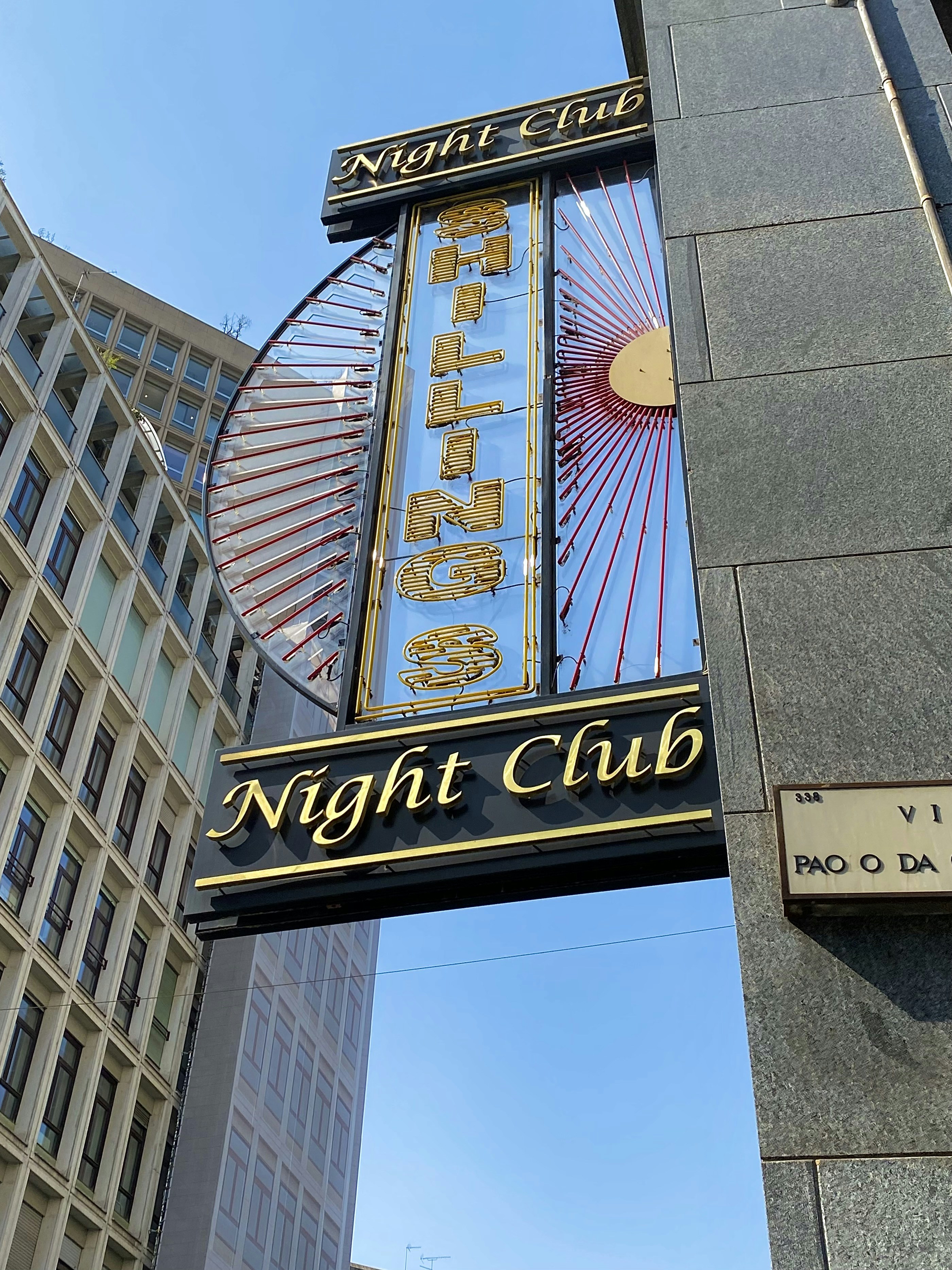 A night club sign hanging off the side of a building photo – Free Milan ...