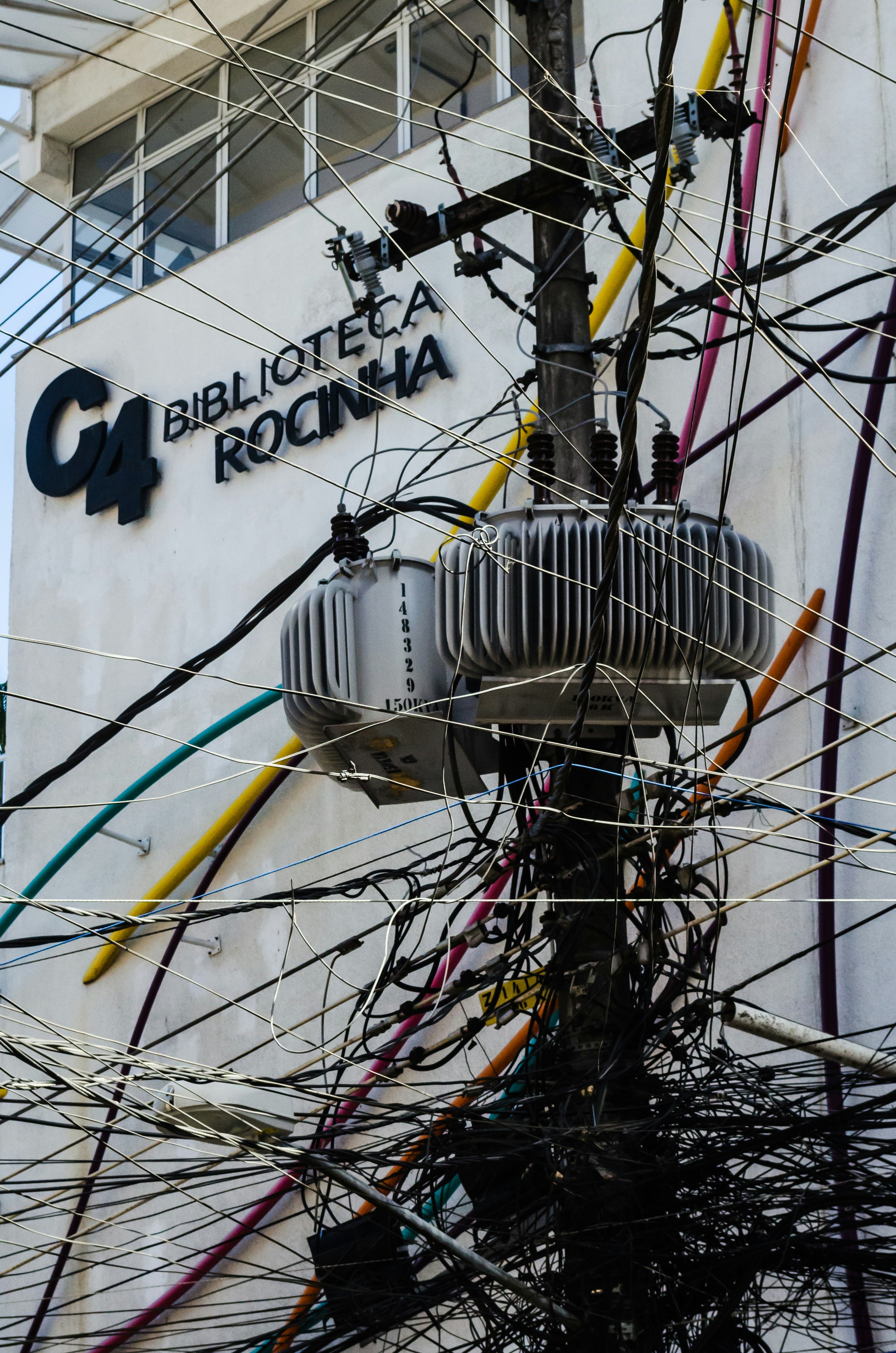 A bunch of wires are tangled up outside of a building photo – Free Grey ...