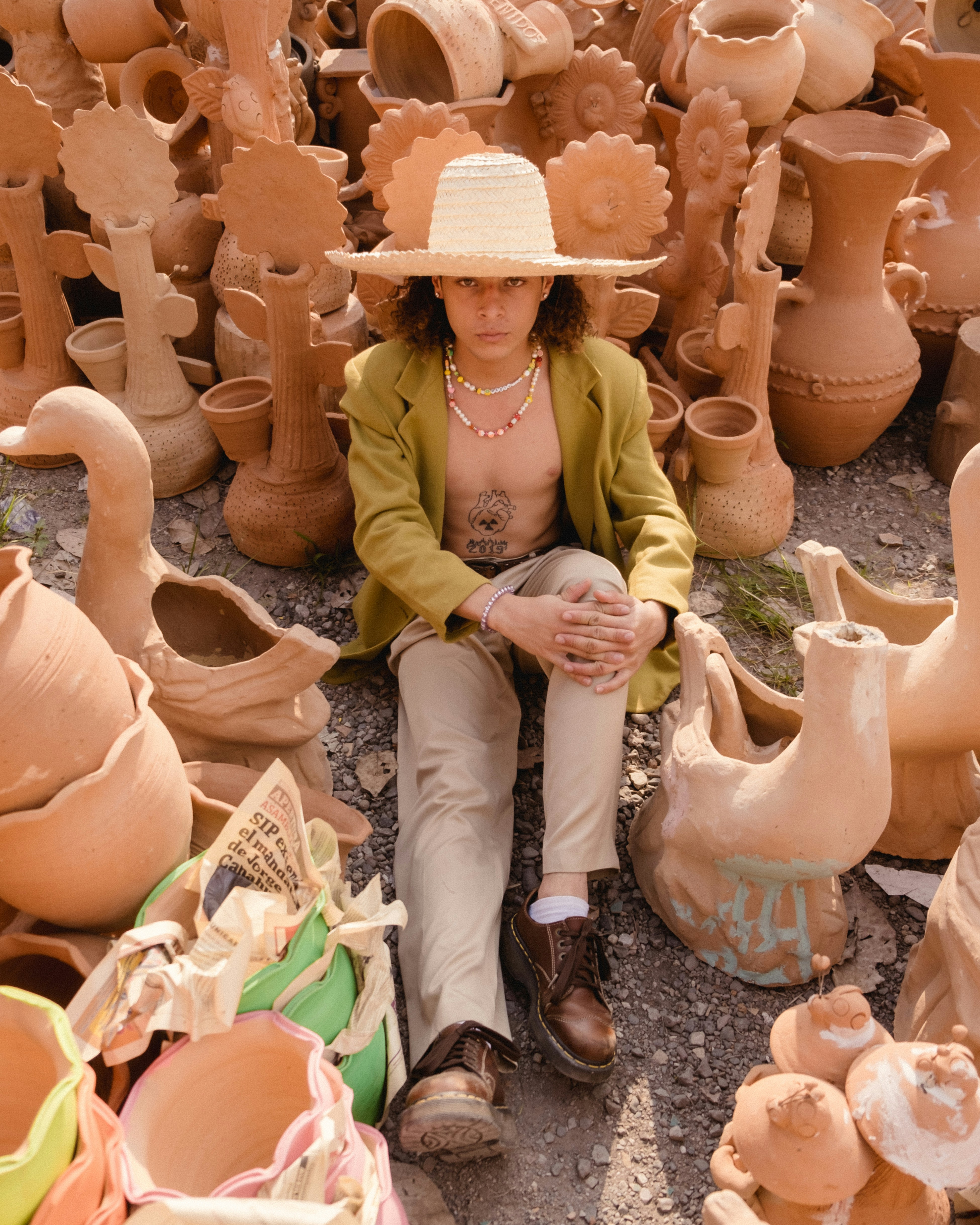 Straw Hat Among Terracotta Seas: A Quiet Portrait in Clay
