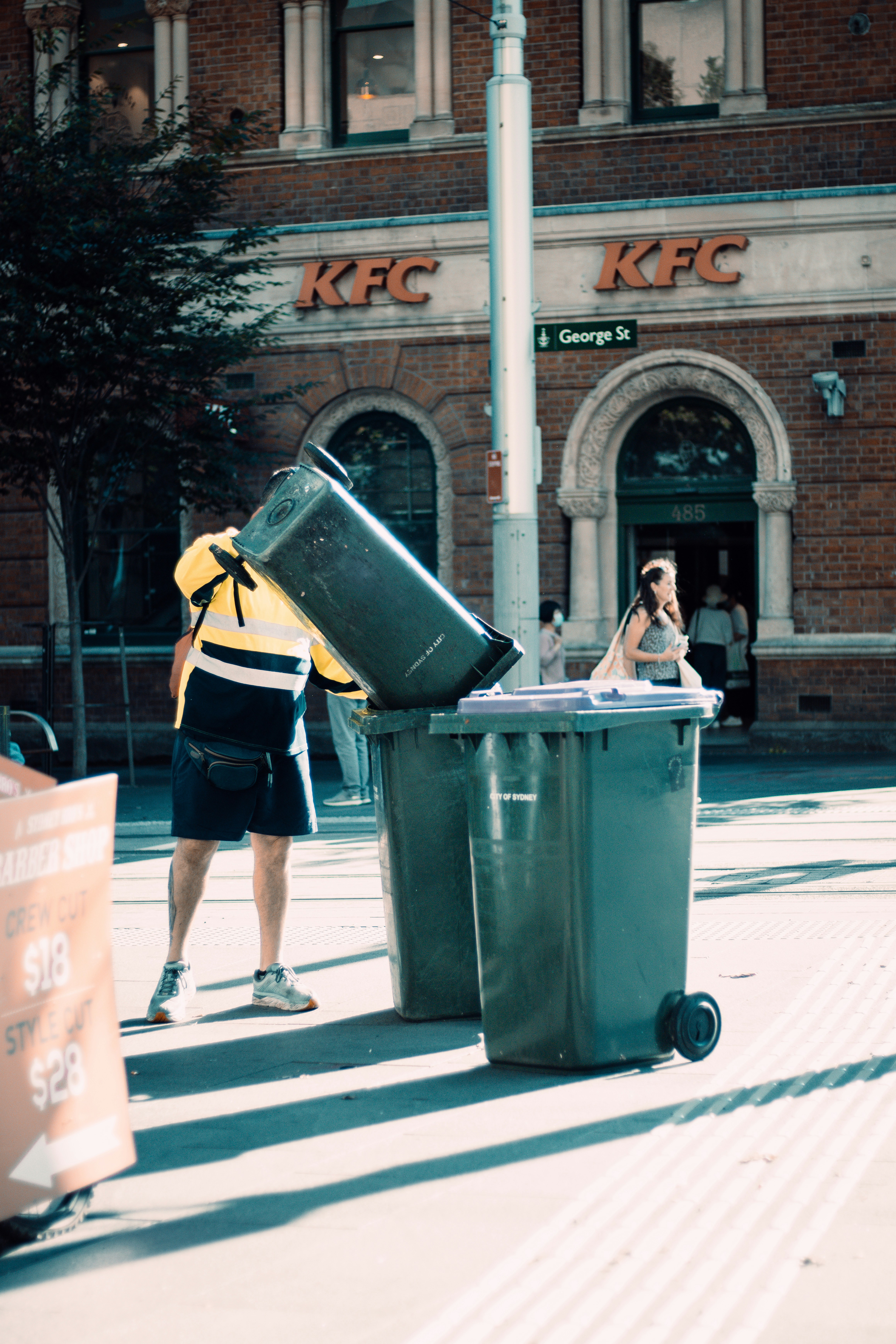 A person standing next to a trash can photo – Free Kfc Image on Unsplash