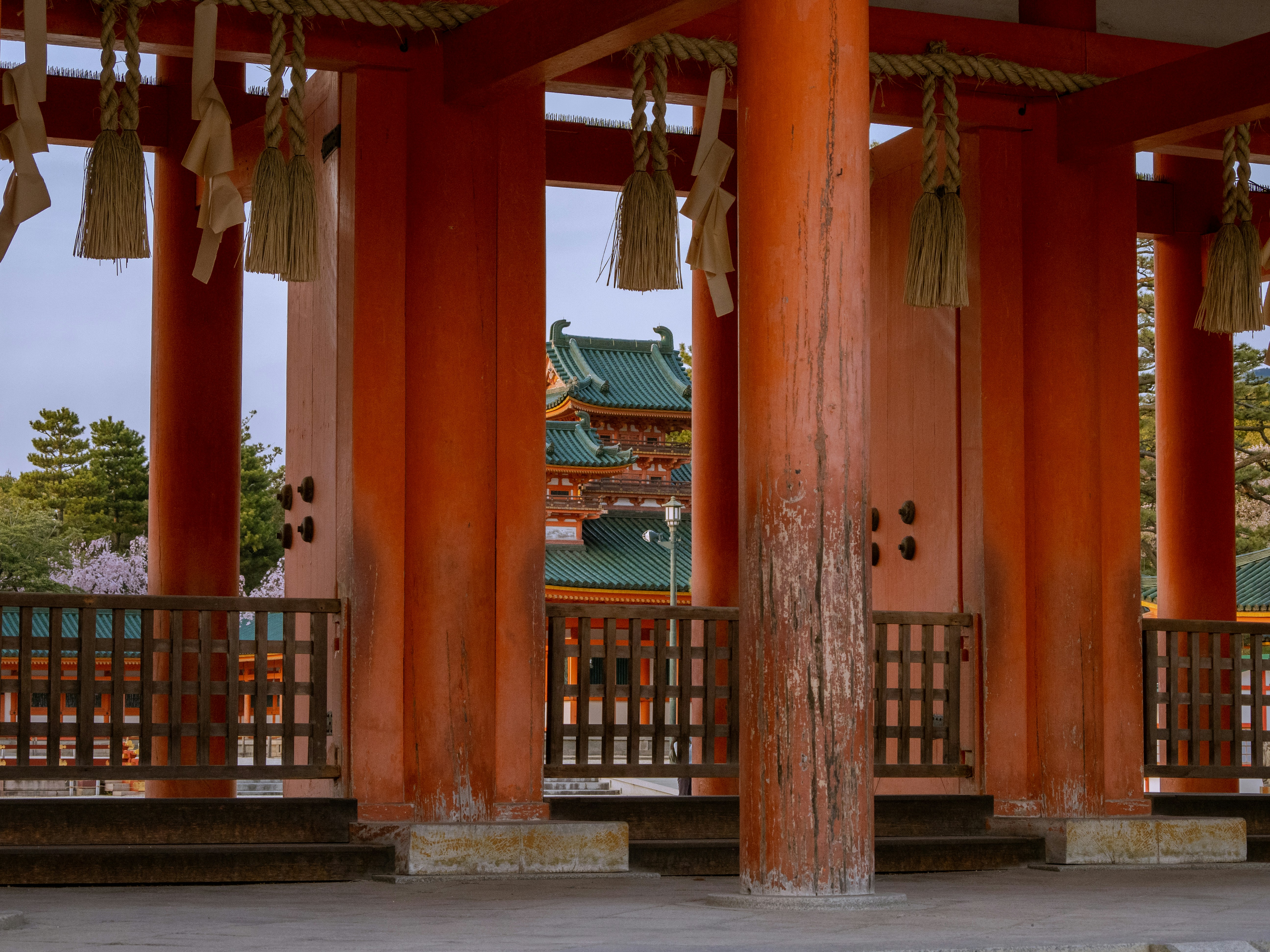 A group of red pillars with tassels hanging from them photo – Free ...