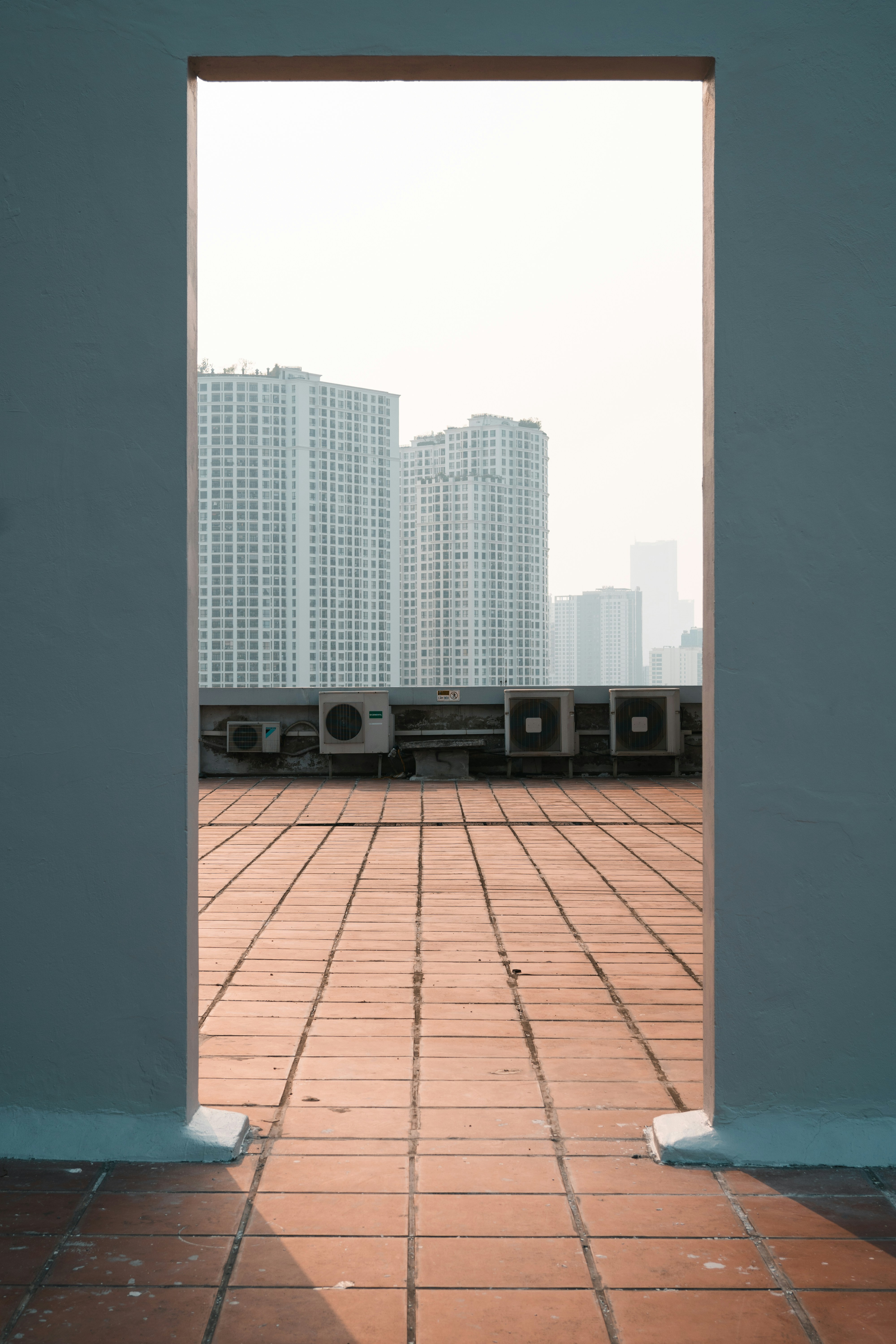 Frame of City Rooftop: Doorway to a distant skyline