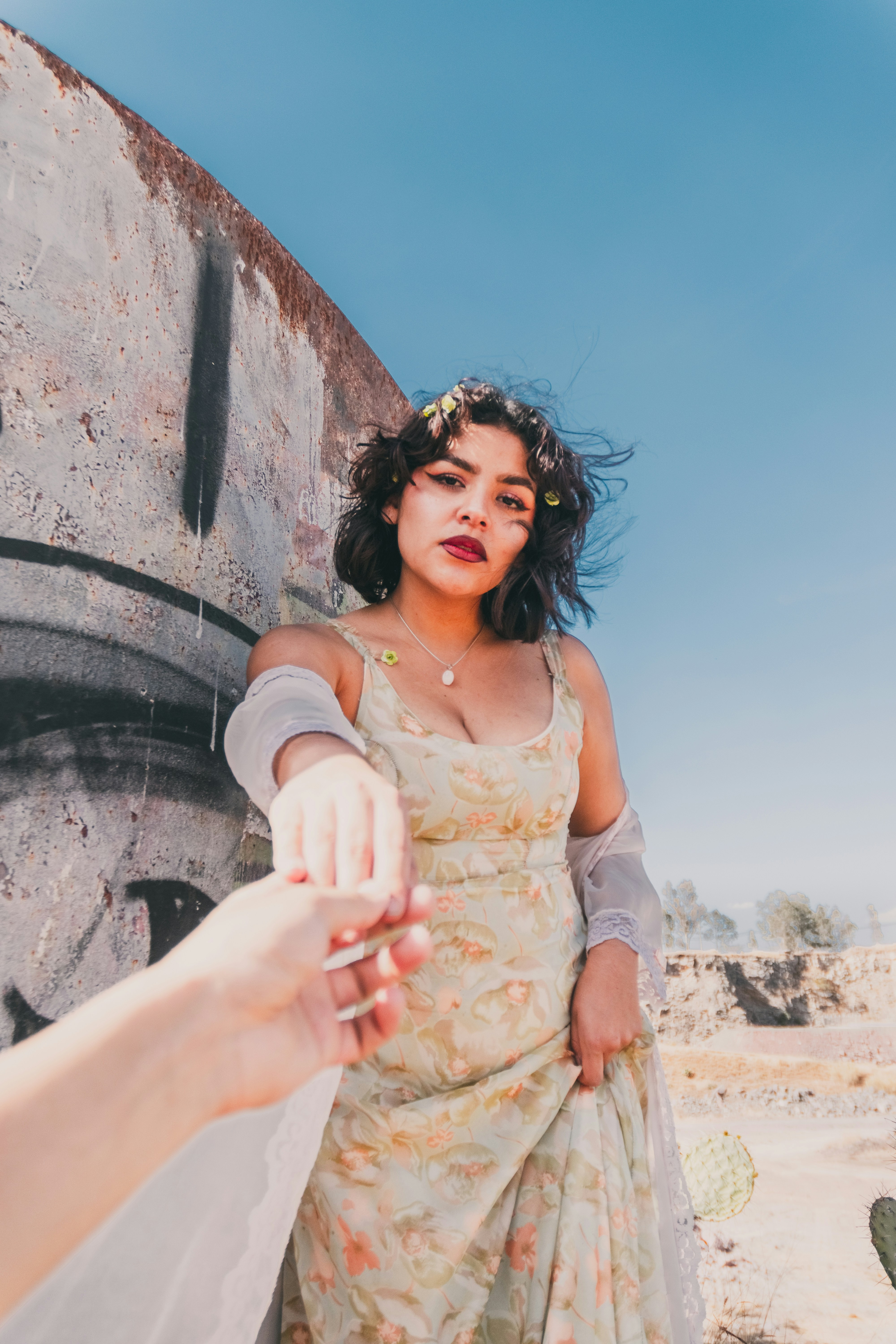 Desert Embrace: A Sunlit Portrait Reaching Toward the Viewer