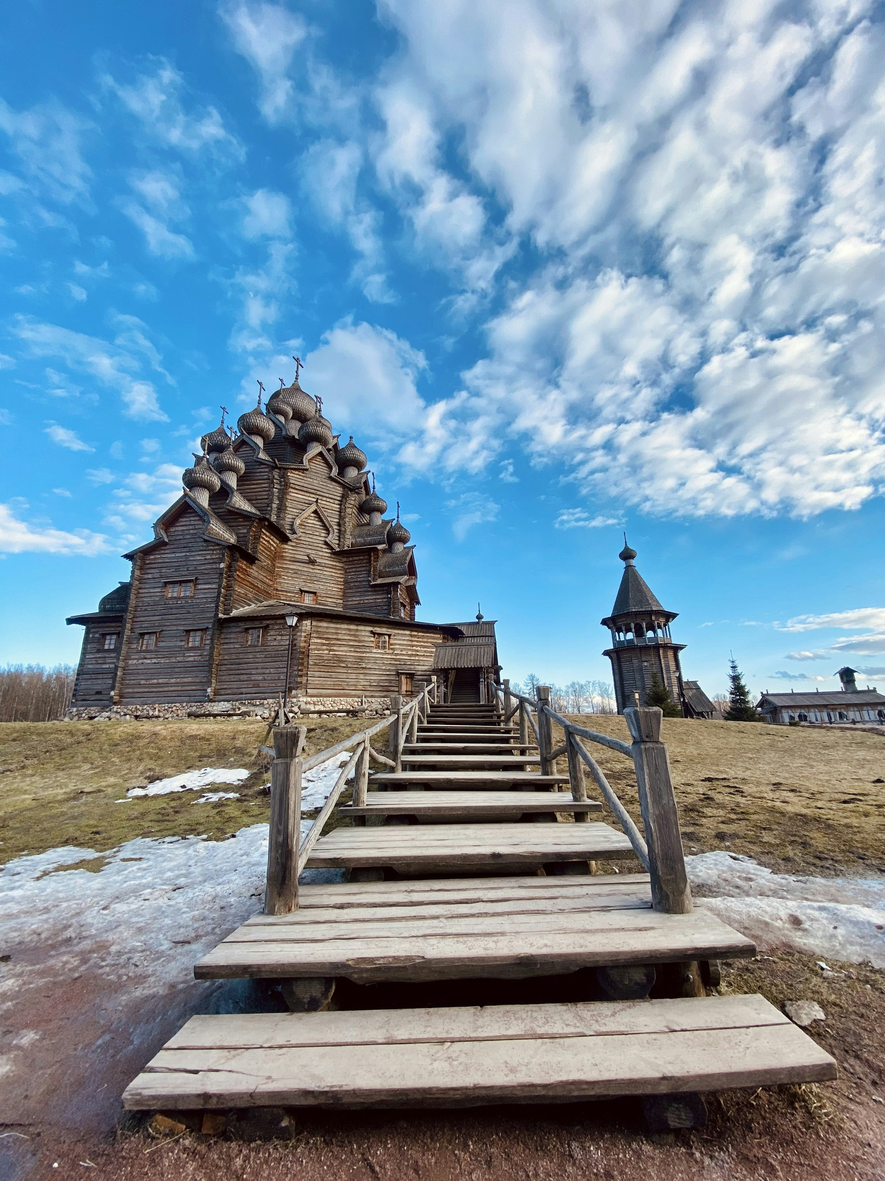 Stairway to a Rustic Dome: A Timber Church Under a Blue Sky