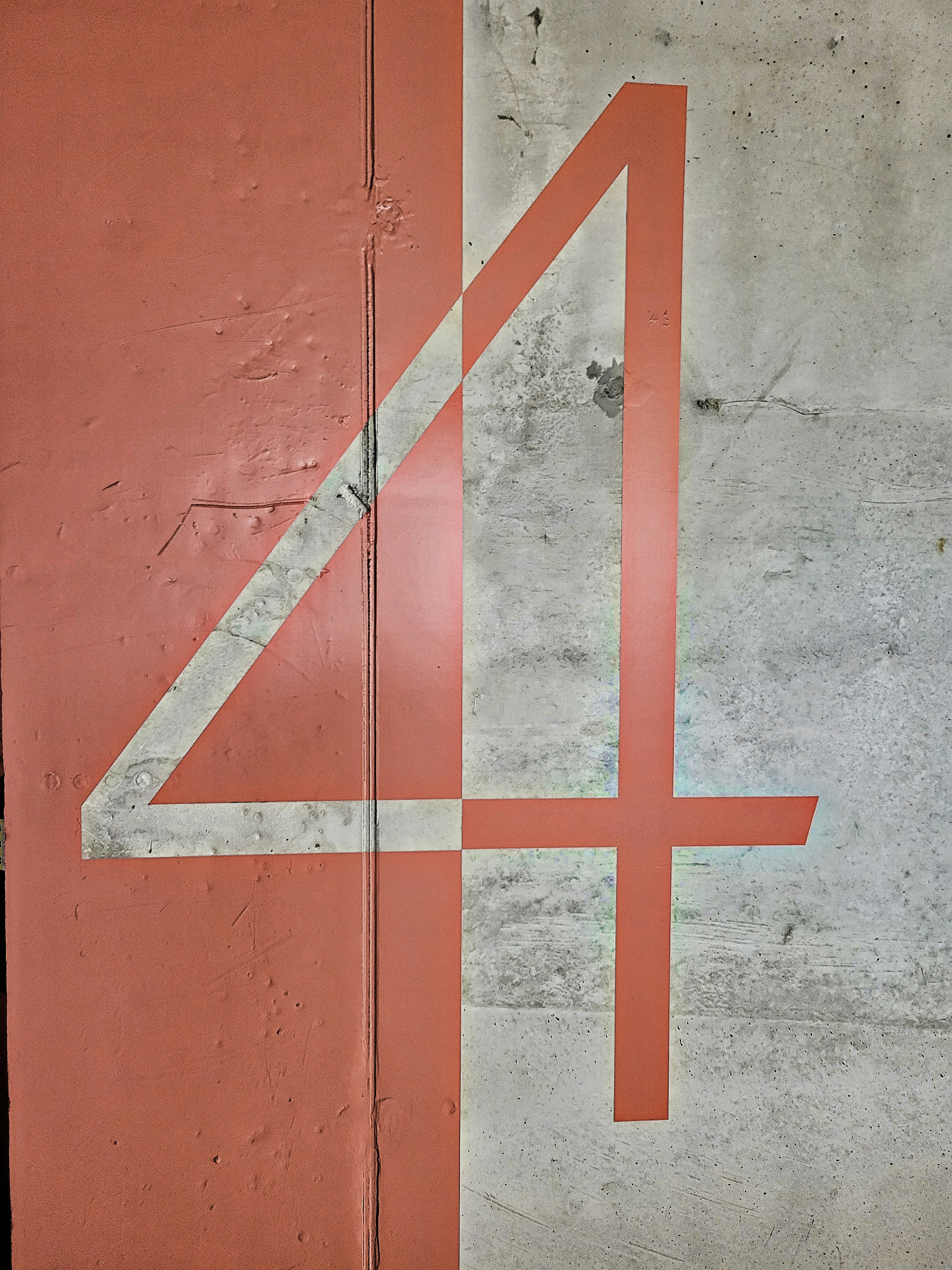 A red and white wall with a number four painted on it photo – Free Grey ...