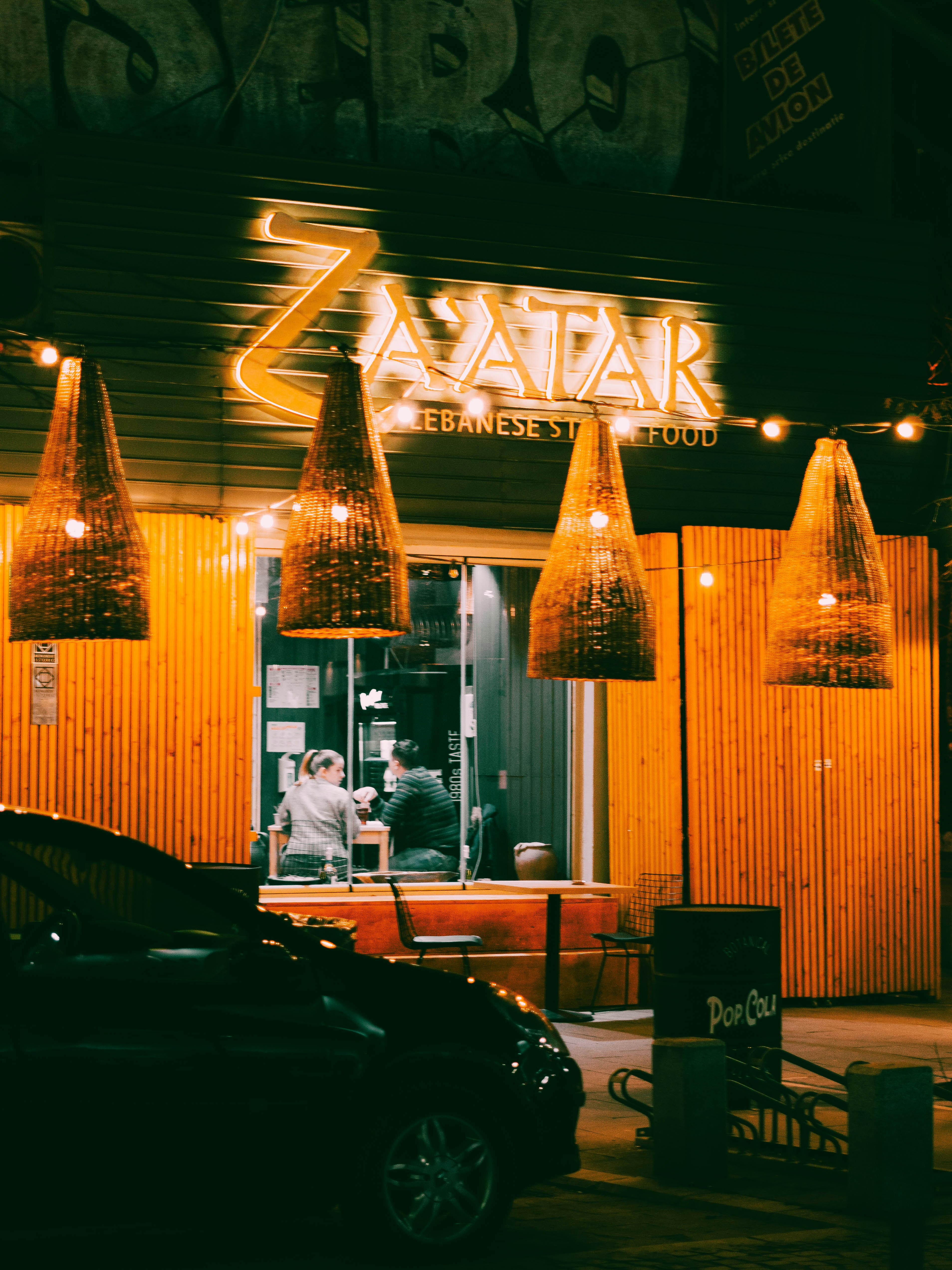 a restaurant with a car parked in front of it