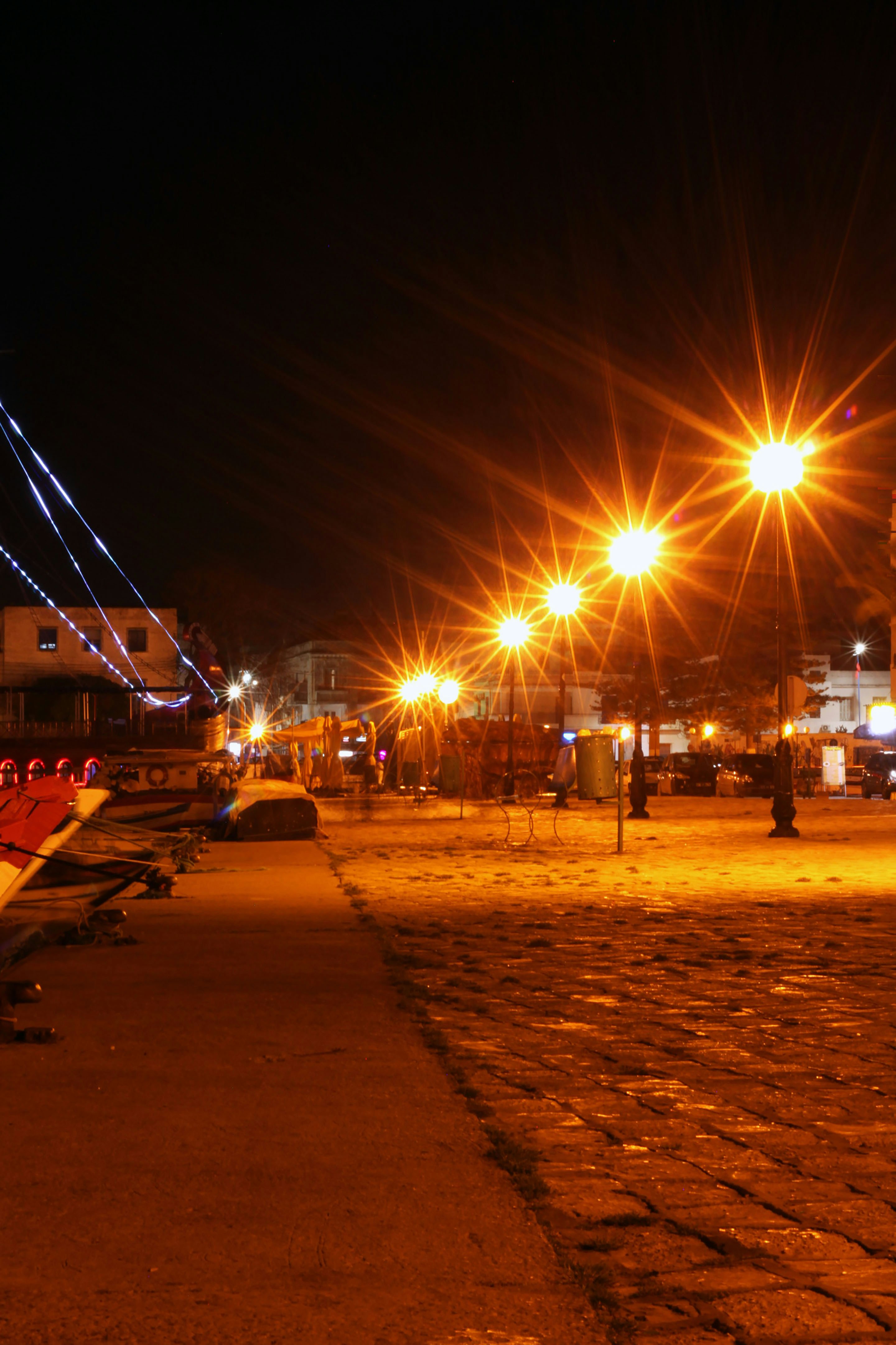 Amber Beacons Along a Night Harbor Promenade