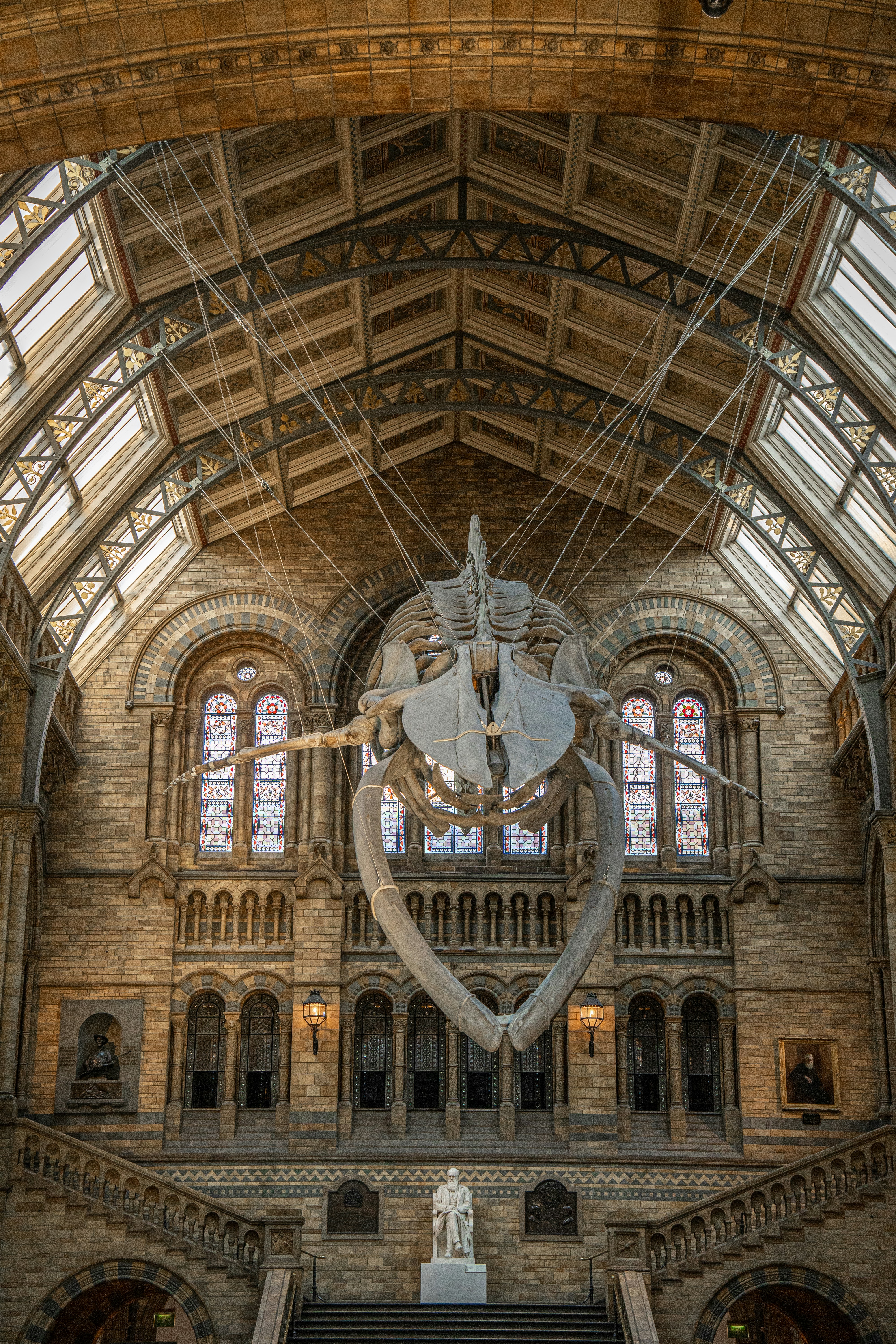 A large building with a statue of a whale hanging from the ceiling ...